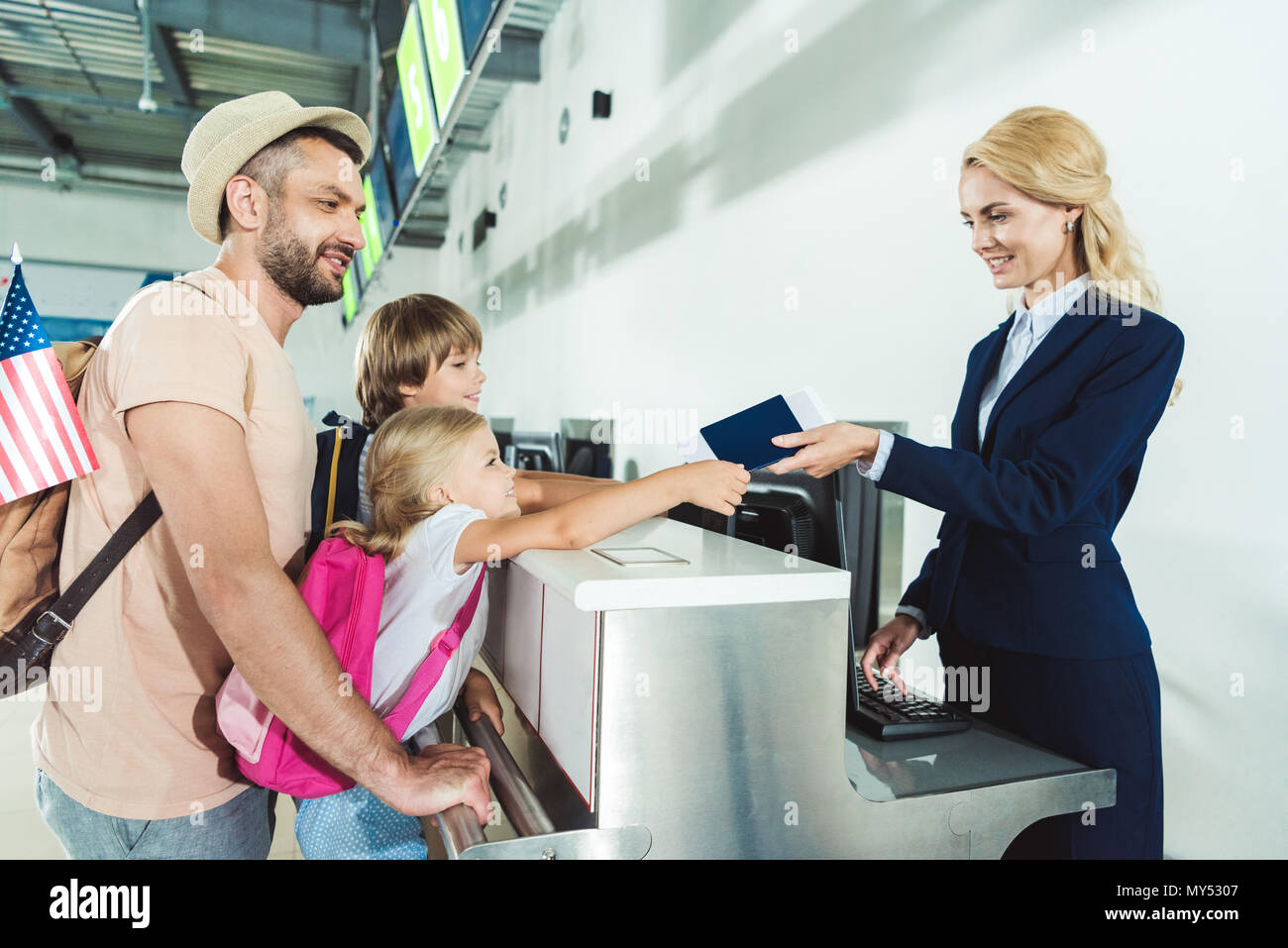 father and kids at check in desk before flight at airport Stock Photo ...