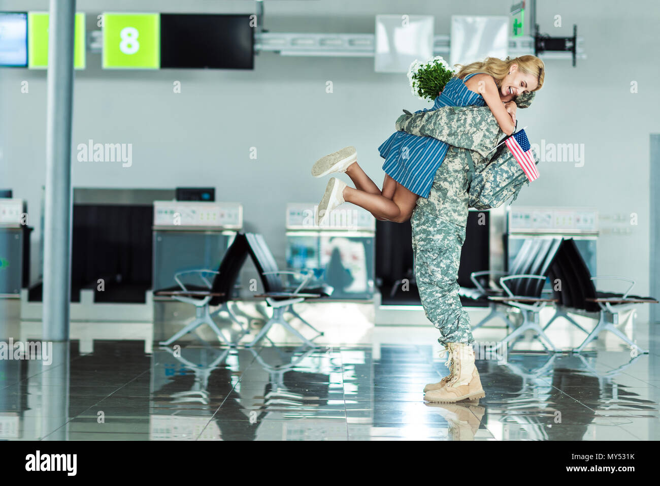 wife meeting husband in military uniform at airport Stock Photo - Alamy