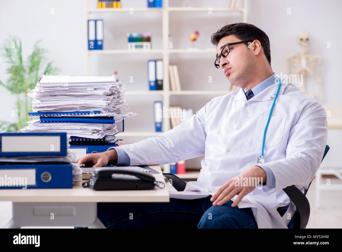 Busy doctor with too much work in hospital Stock Photo - Alamy