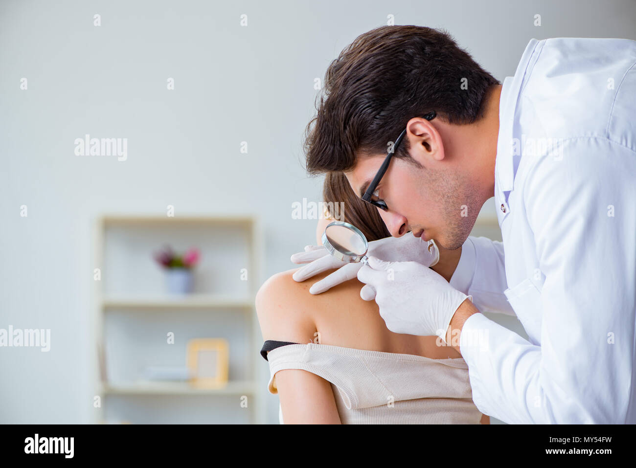 Doctor examining the skin of female patient Stock Photo - Alamy