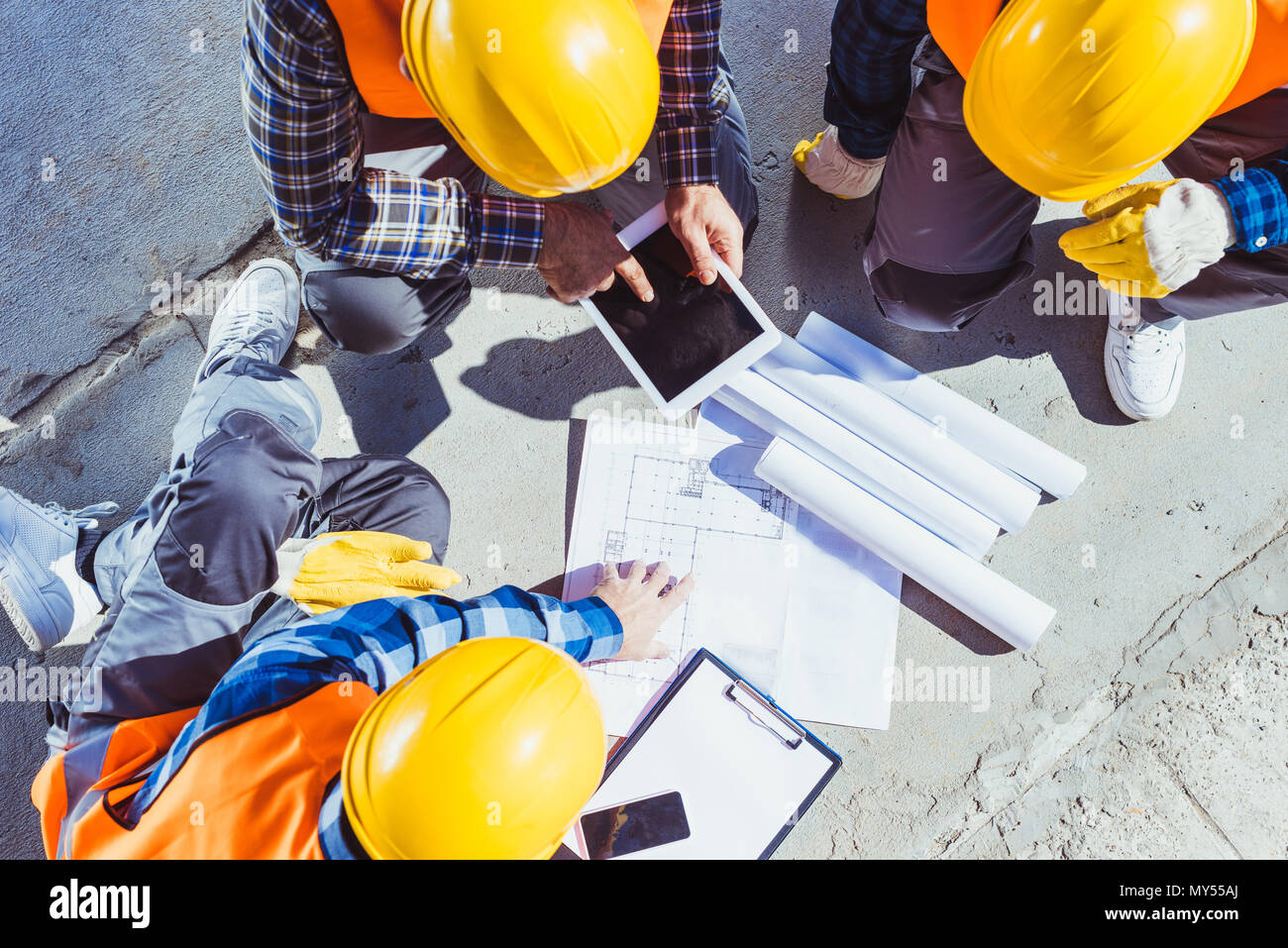 Three construction workers sitting on hi-res stock photography and ...