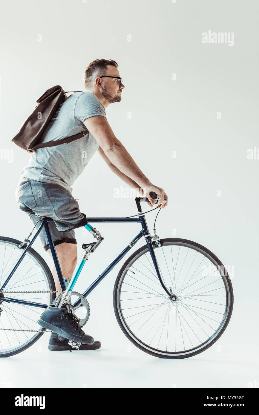 side view of man with backpack on bicycle isolated on white Stock Photo ...