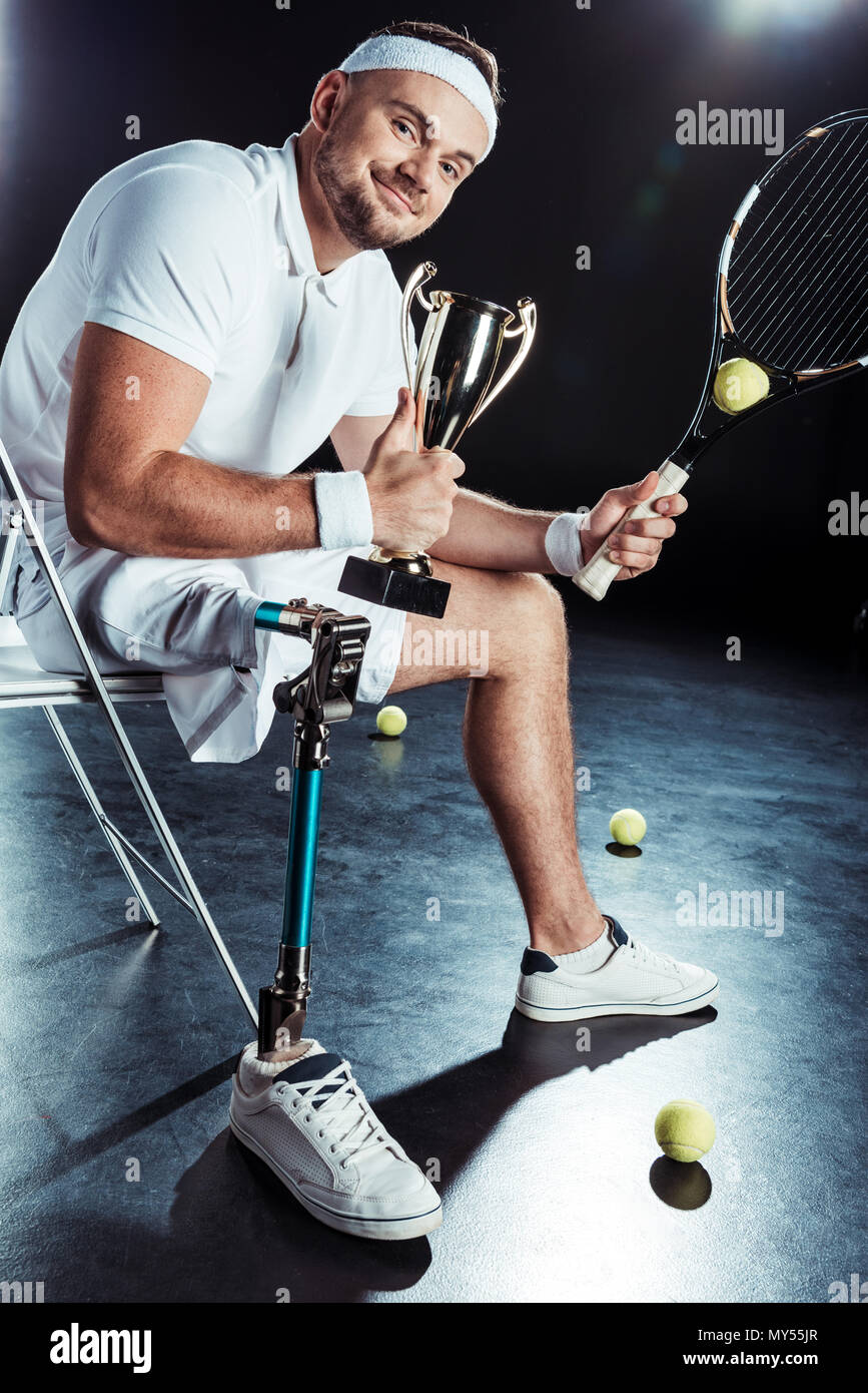 happy tennis player with champion goblet resting on chair Stock Photo ...