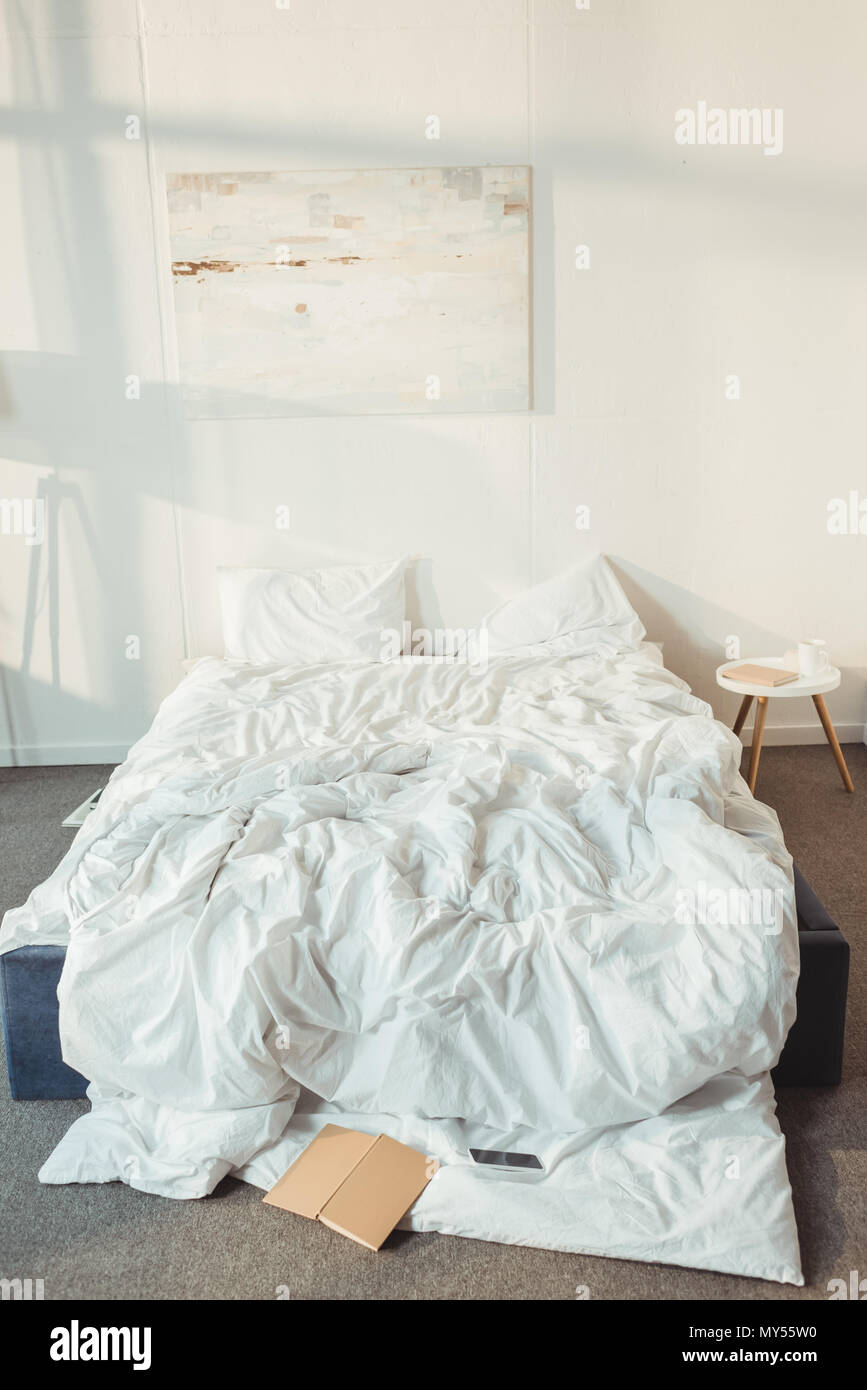 interior of modern bedroom at morning with mess on bed Stock Photo - Alamy