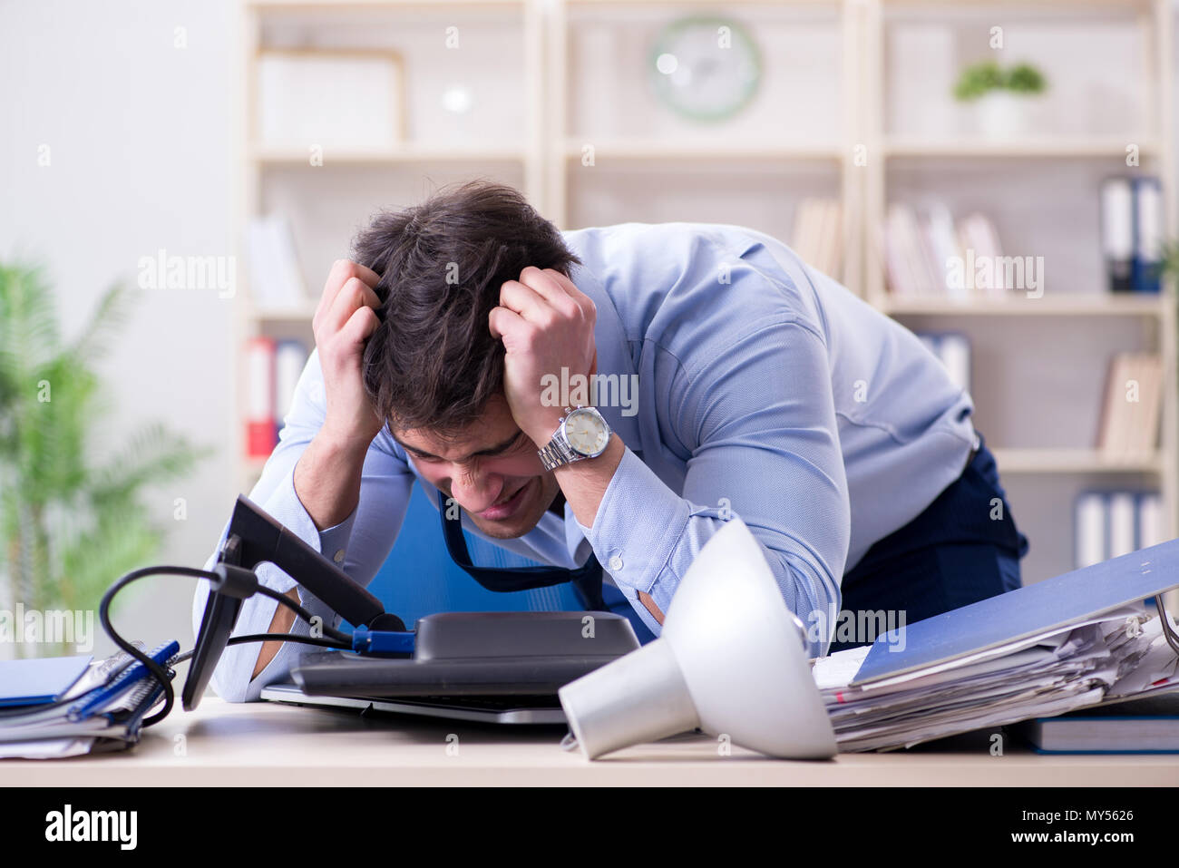 Angry businessman frustrated with too much work Stock Photo - Alamy