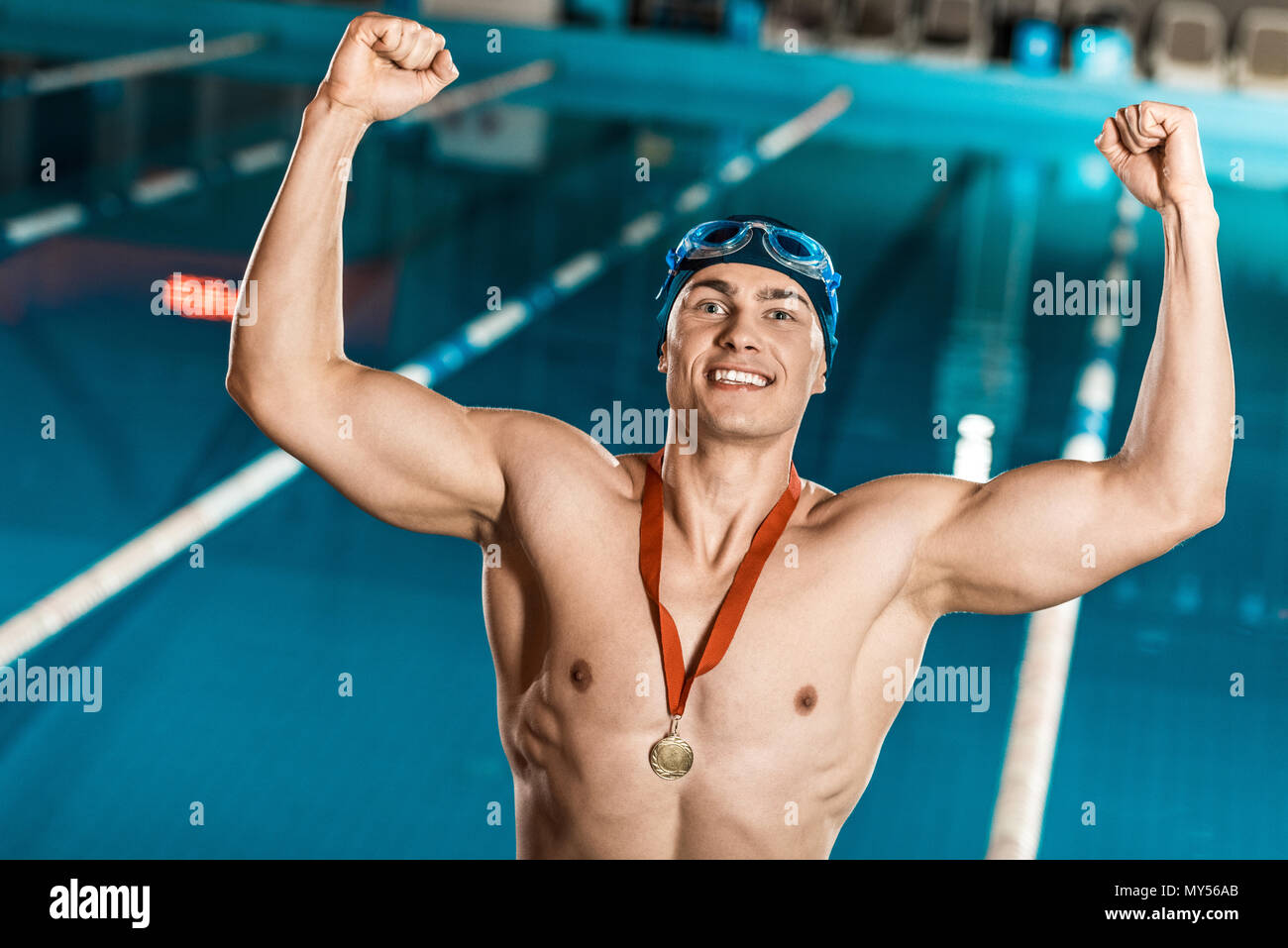 winner with medal standing at competition swimming pool Stock Photo - Alamy