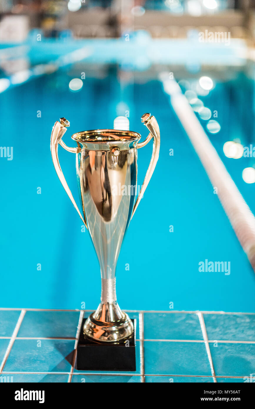 golden trophy cup at competition swimming pool Stock Photo - Alamy