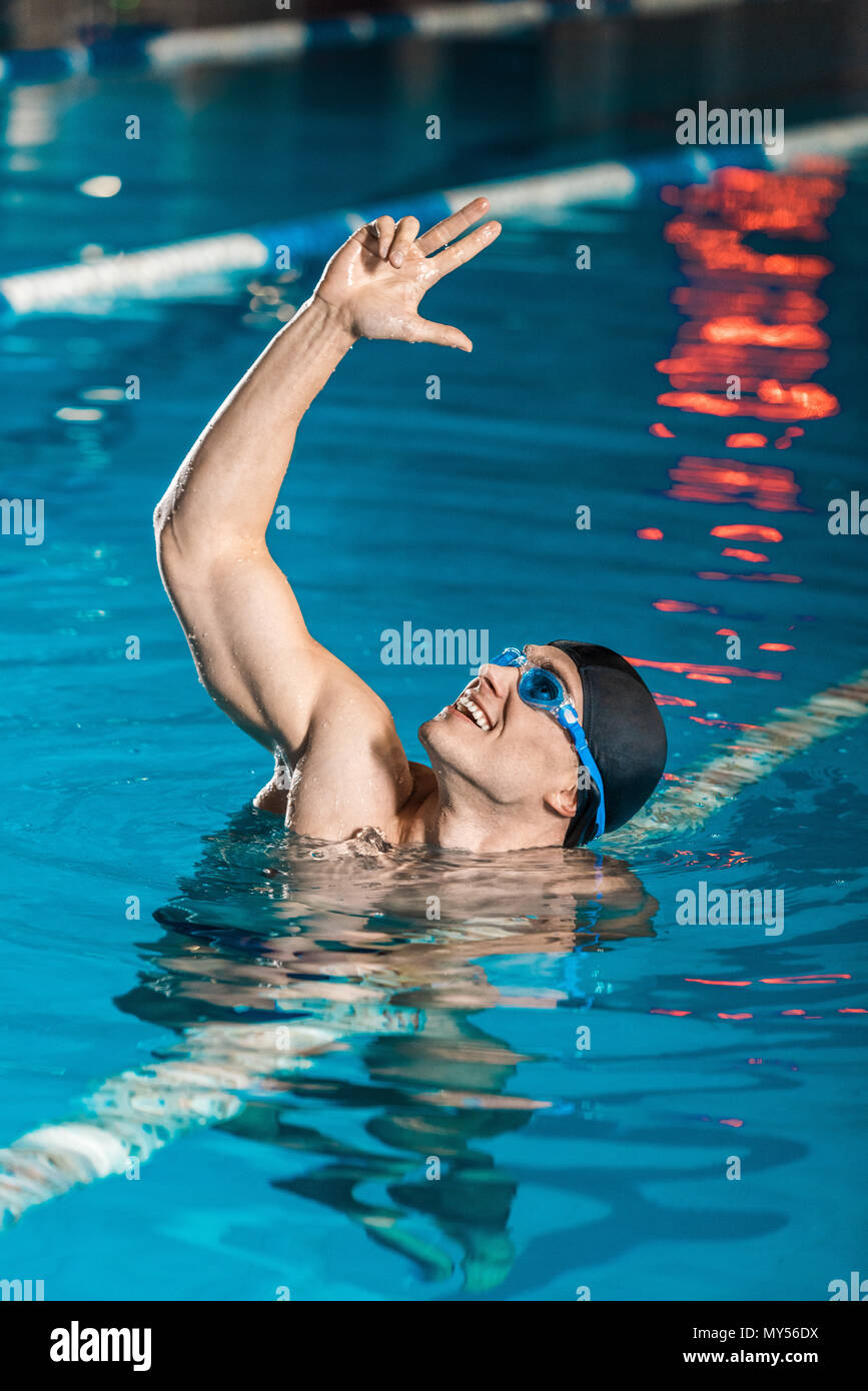 handsome smiling muscular swimmer in competition swimming pool Stock ...