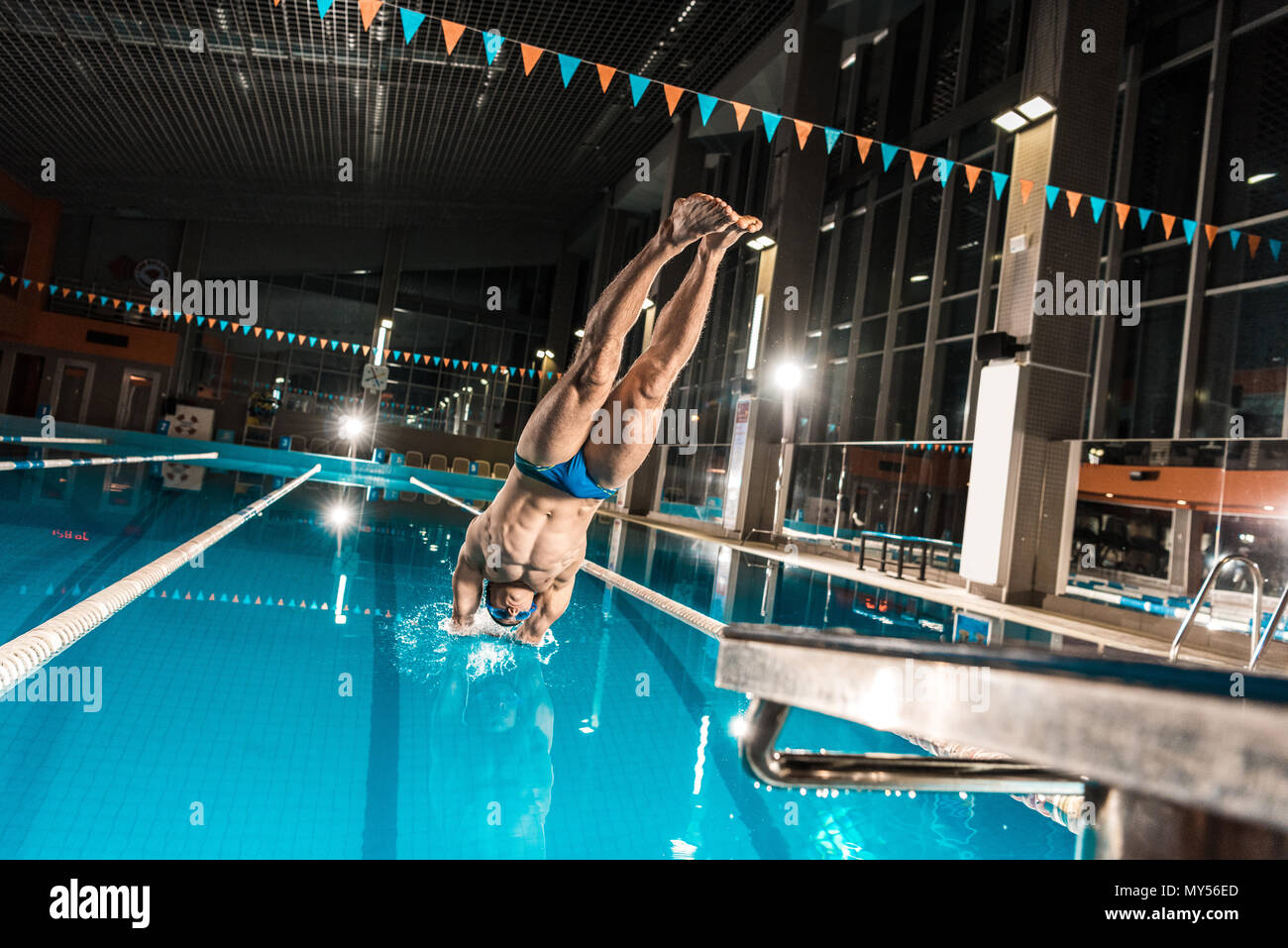 swimmer diving in competition swimming pool Stock Photo - Alamy