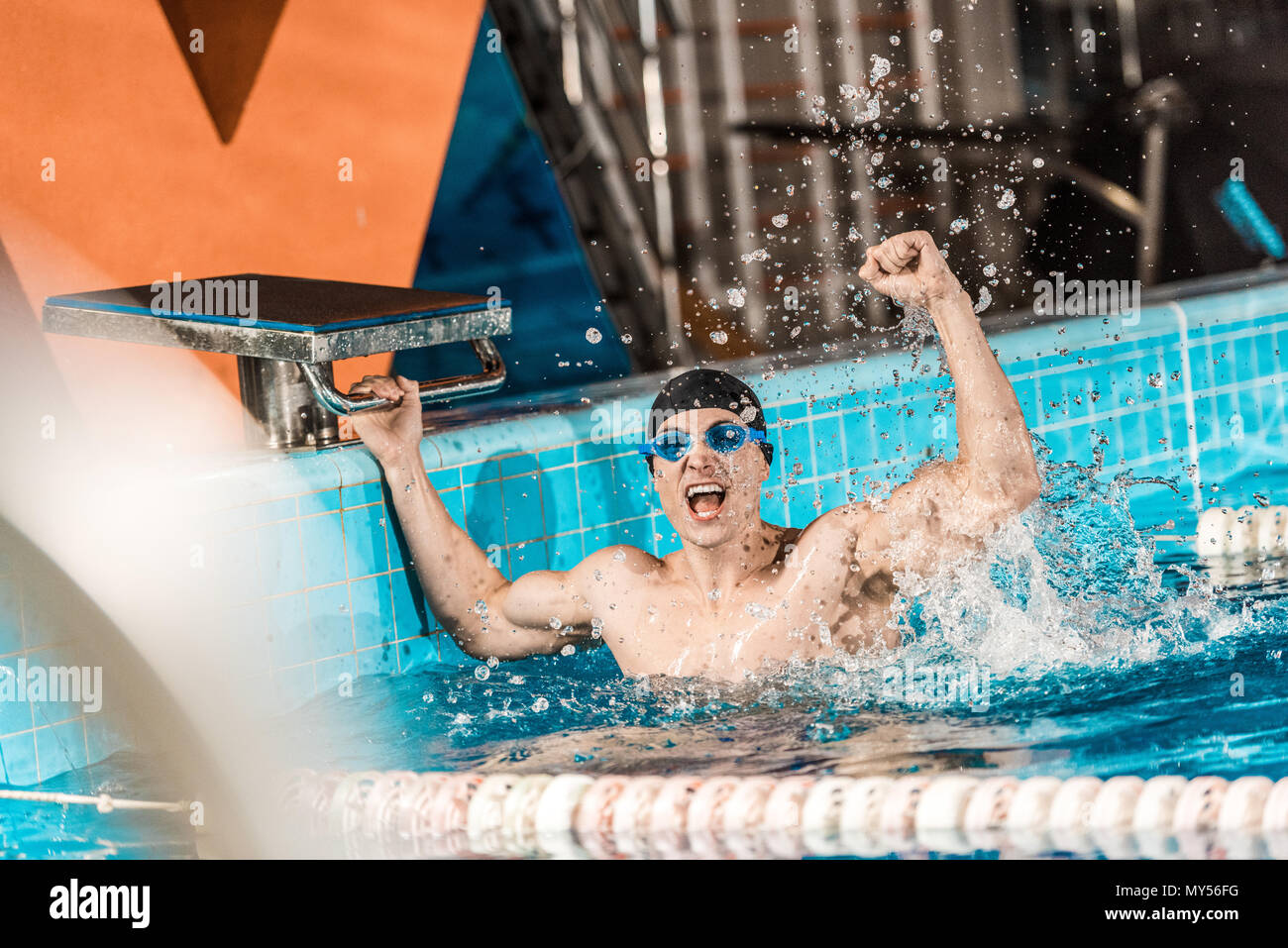 excited male winner in competition swimming pool Stock Photo - Alamy