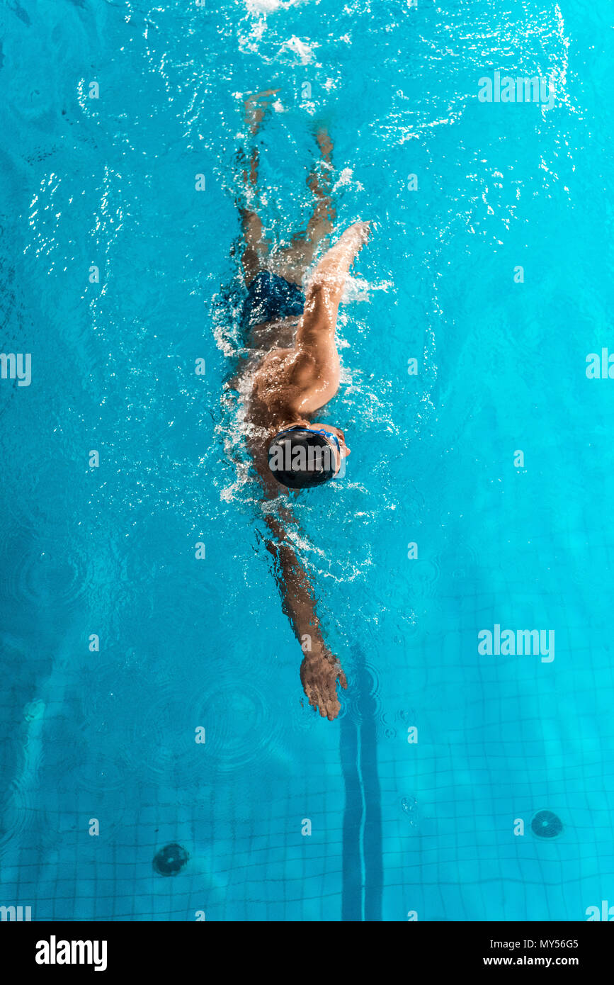top view of young professional swimmer in competition swimming pool ...