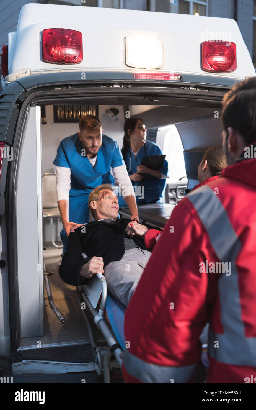 Paramedics moving ambulance stretcher hi-res stock photography and ...