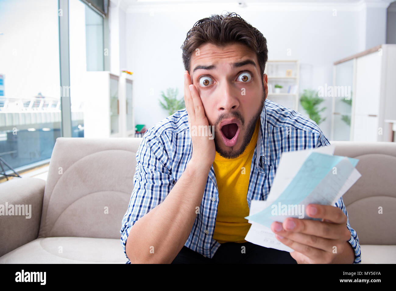 Man angry at bills he needs to pay Stock Photo - Alamy