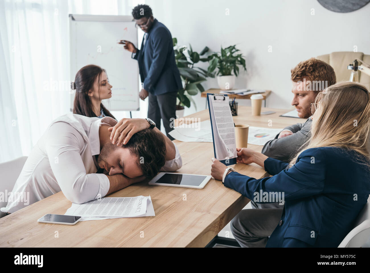 sleepy businesspeople having conversation at office Stock Photo - Alamy