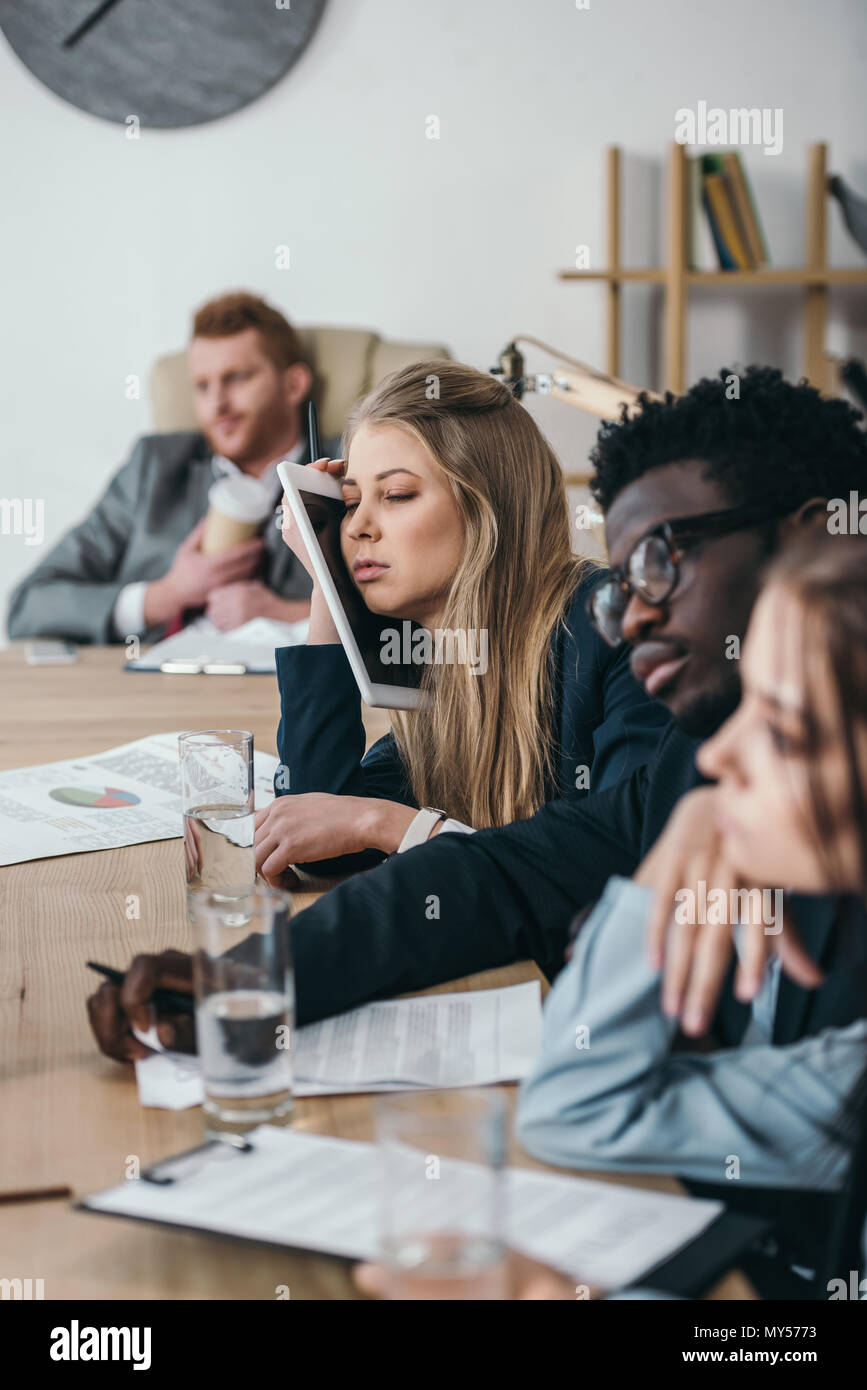 exhausted zombie like businesspeople sitting in conference hall Stock ...