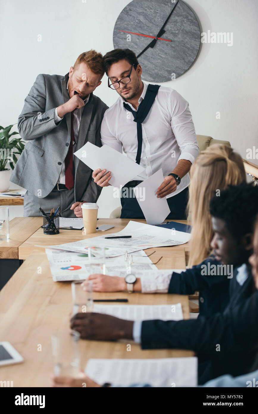 group of managers having conversation in conference hall at office ...