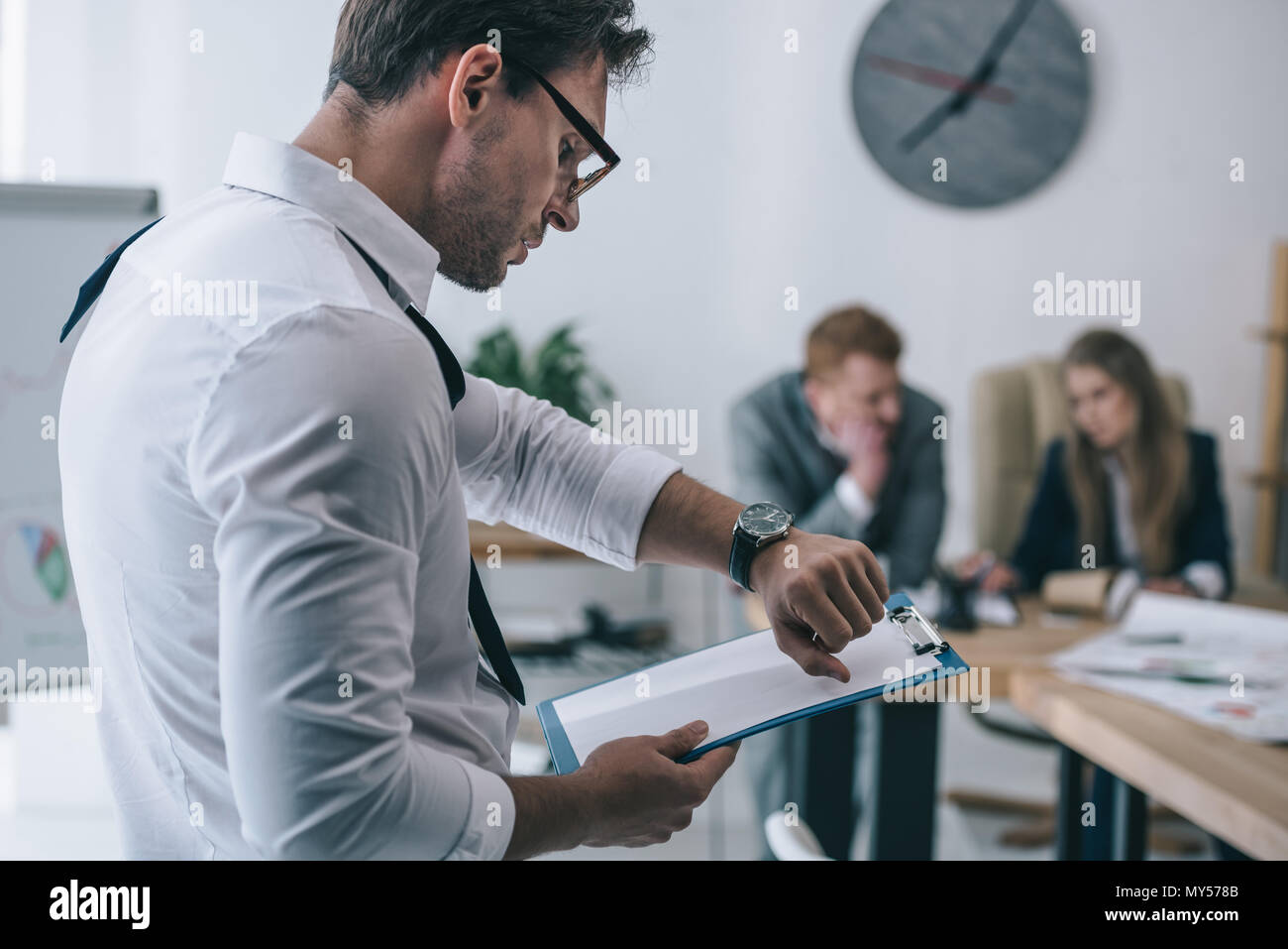 Businessmen checking the time hi-res stock photography and images - Alamy