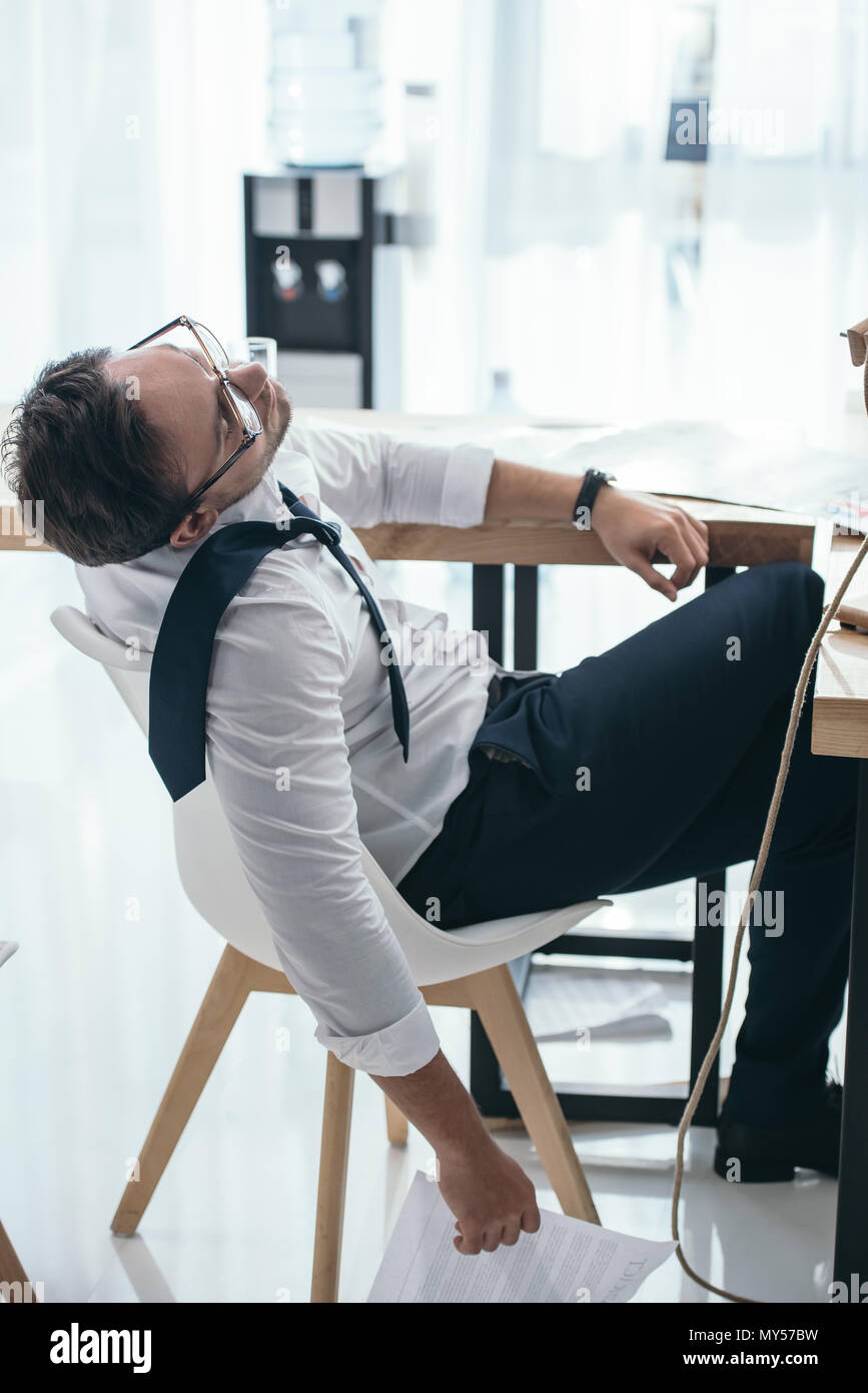 Businessman sleeping on chair hi-res stock photography and images - Alamy