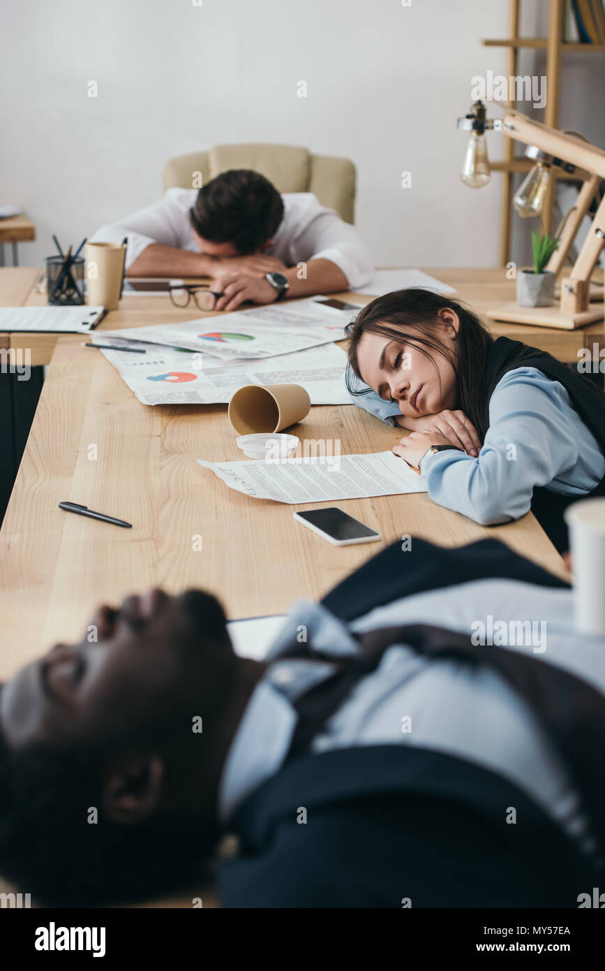 group of businesspeople sleeping in conference hall at office Stock ...