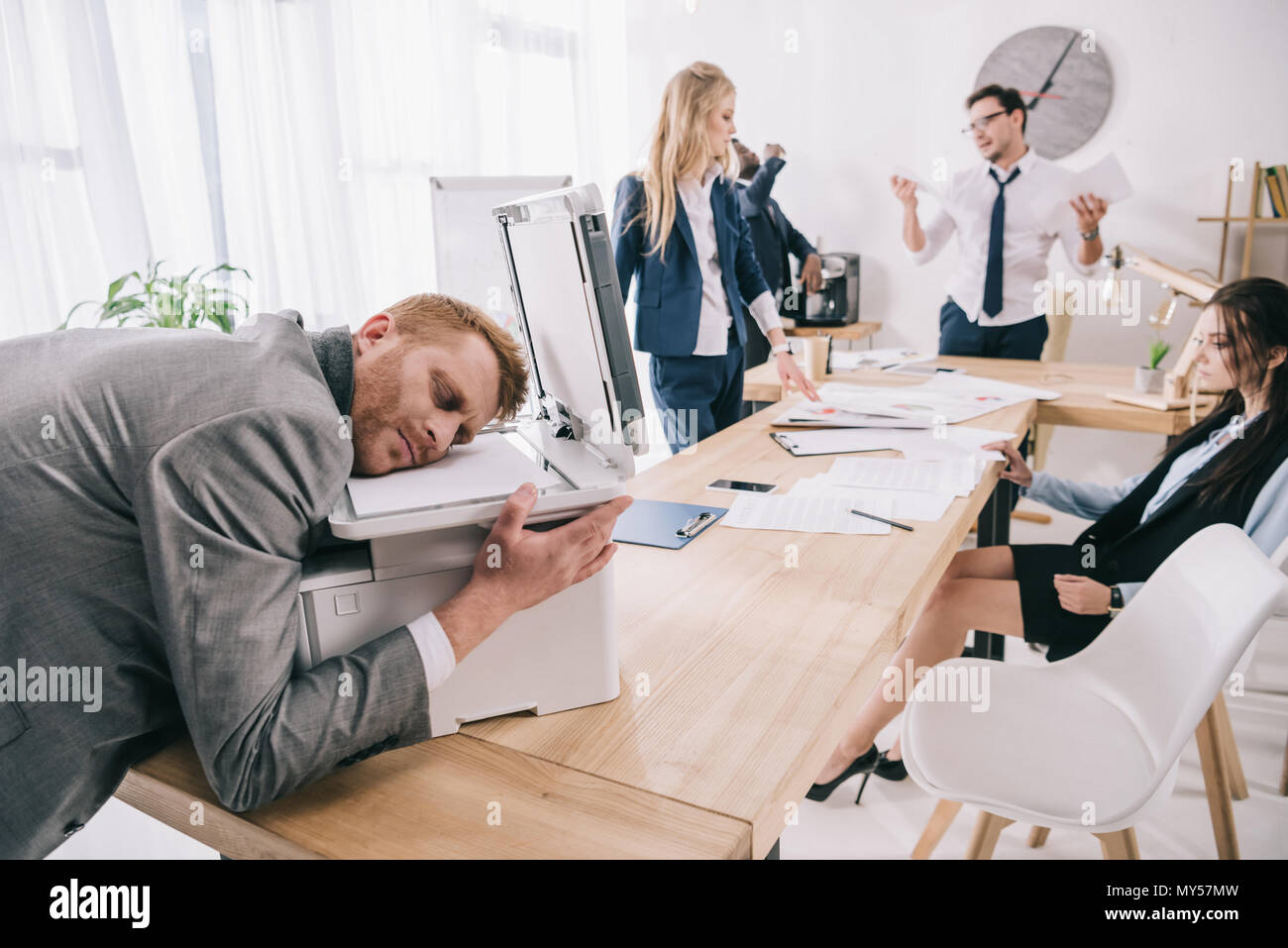 exhausted zombie like businessman sleeping on copier while his ...