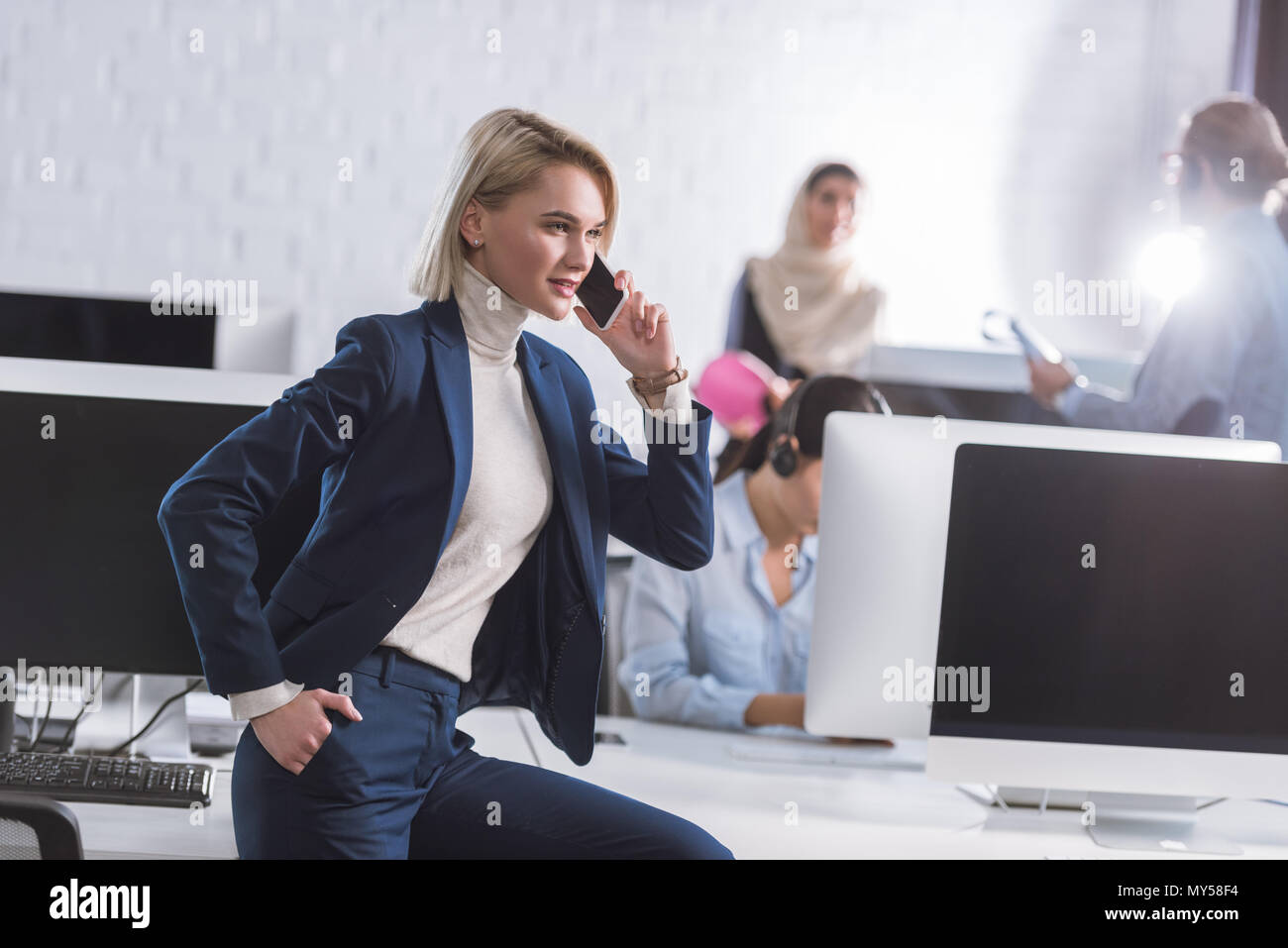 selective focus of confident businesswoman talking on smartphone during ...