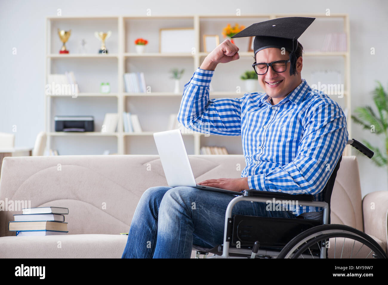 Young student on wheelchair in disability concept Stock Photo - Alamy