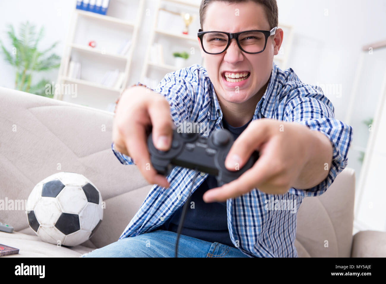 Young man playing computer games at home Stock Photo - Alamy