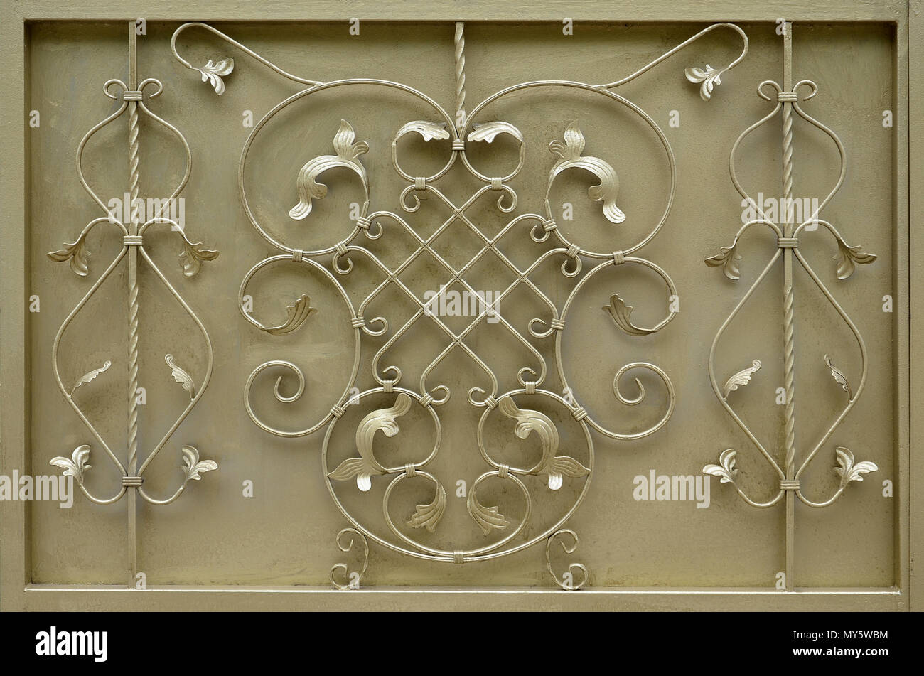 The texture of the golden metal gate with a beautiful floral pattern of ...
