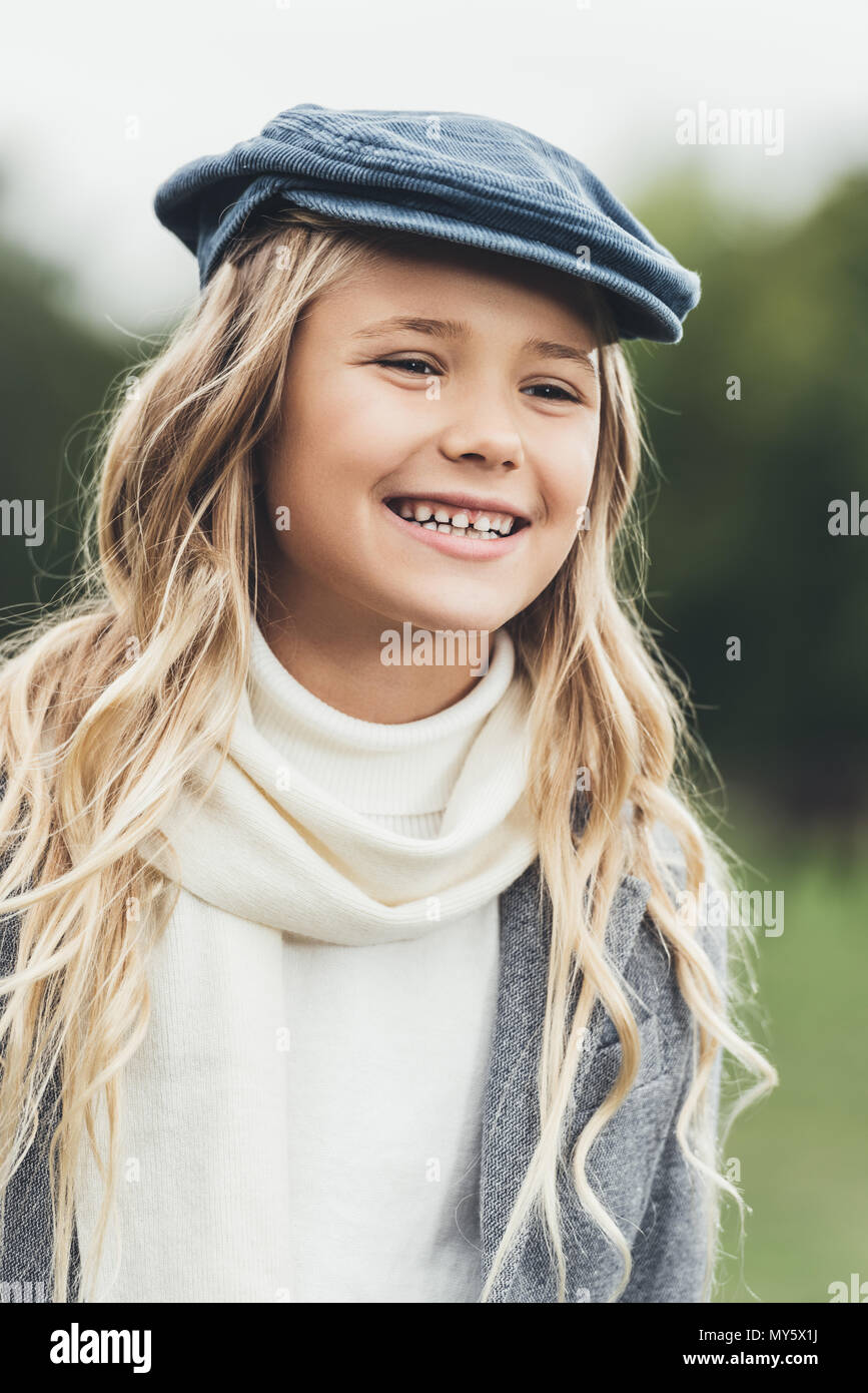adorable blonde child sitting on fence at countryside Stock Photo - Alamy
