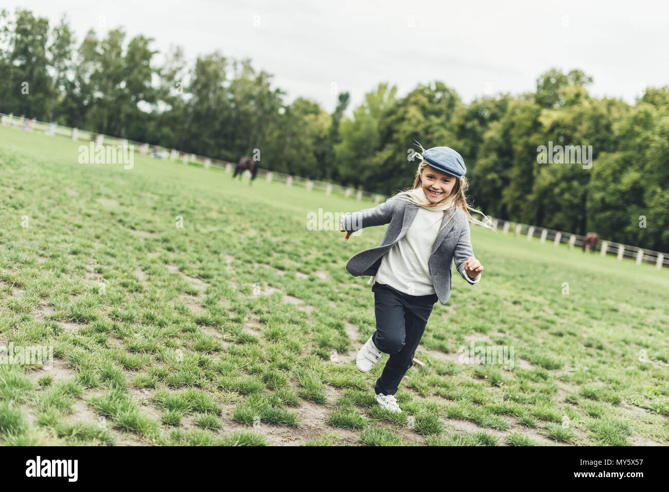cheerful adorable blonde child running at countryside Stock Photo - Alamy