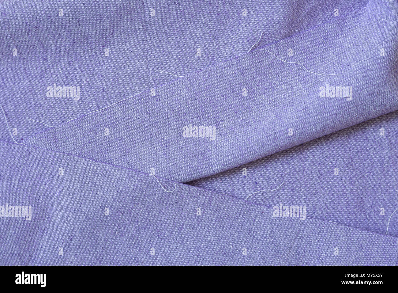 Purple color fabric fold background Stock Photo - Alamy