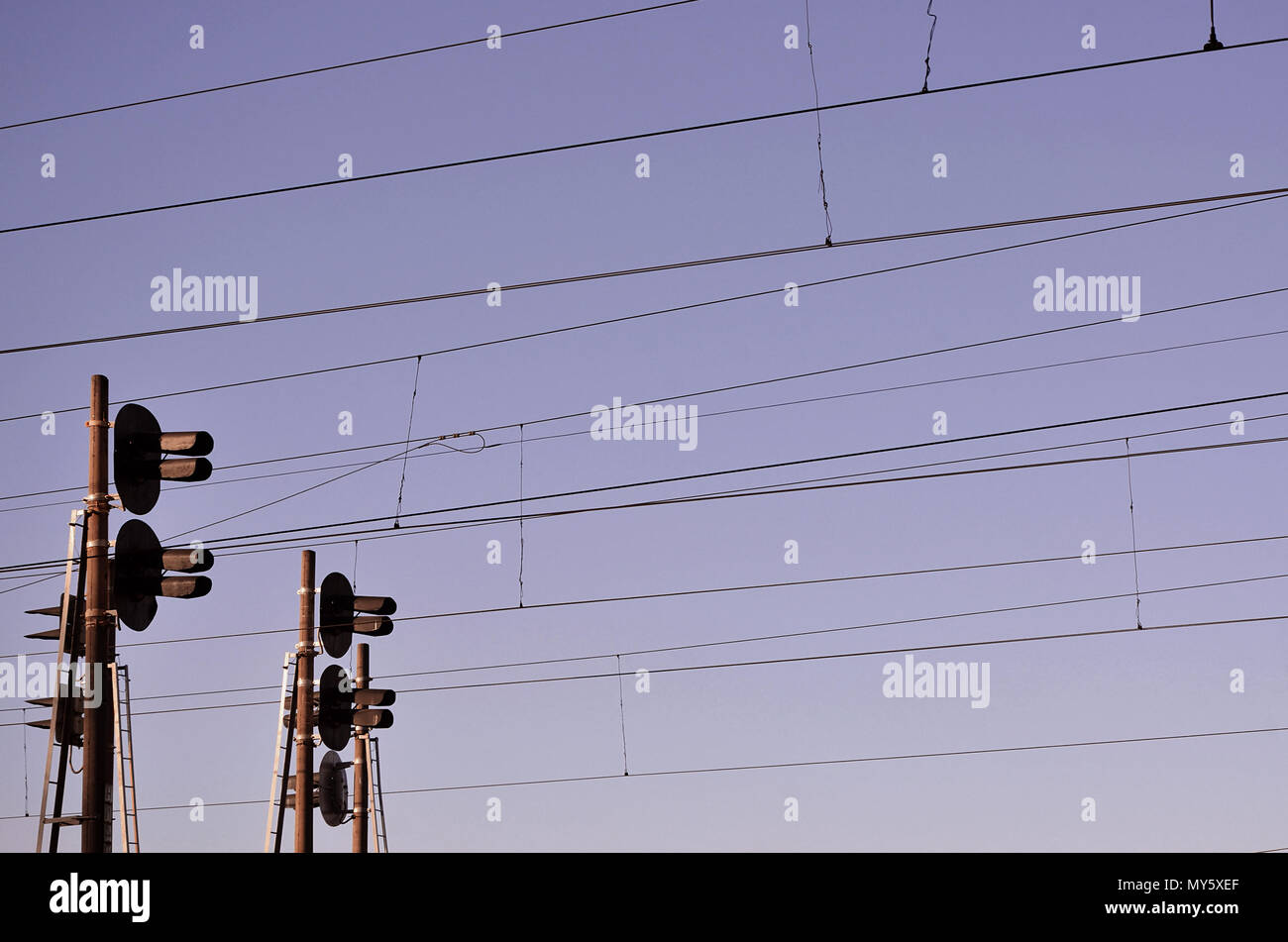 Railroad traffic light against clear blue sky, Contact wire. High ...