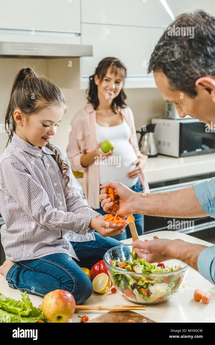 happy smiling family making salad together at kitchen Stock Photo - Alamy