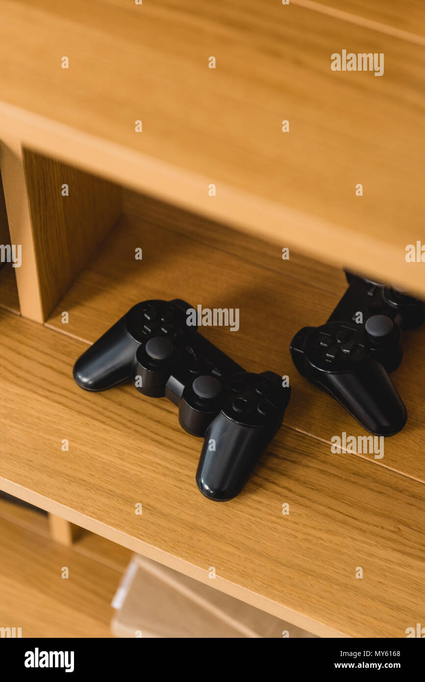 overhead view of two game pads on wooden shelves Stock Photo - Alamy