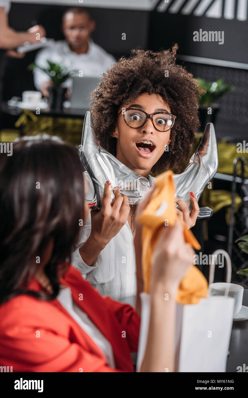 shocked young woman with glossy silver boots Stock Photo - Alamy