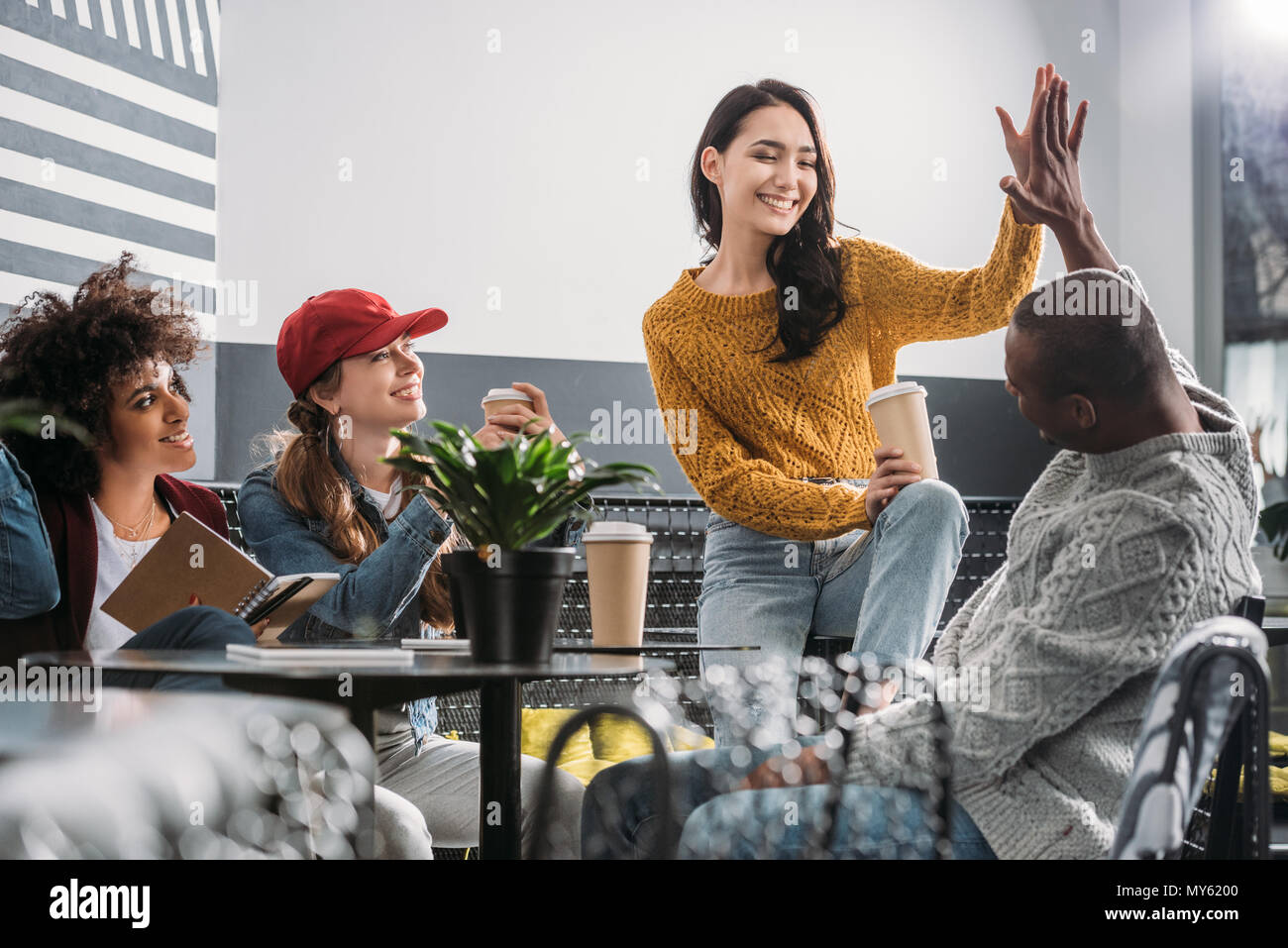 Happy friends cups hot drinks hi-res stock photography and images - Alamy