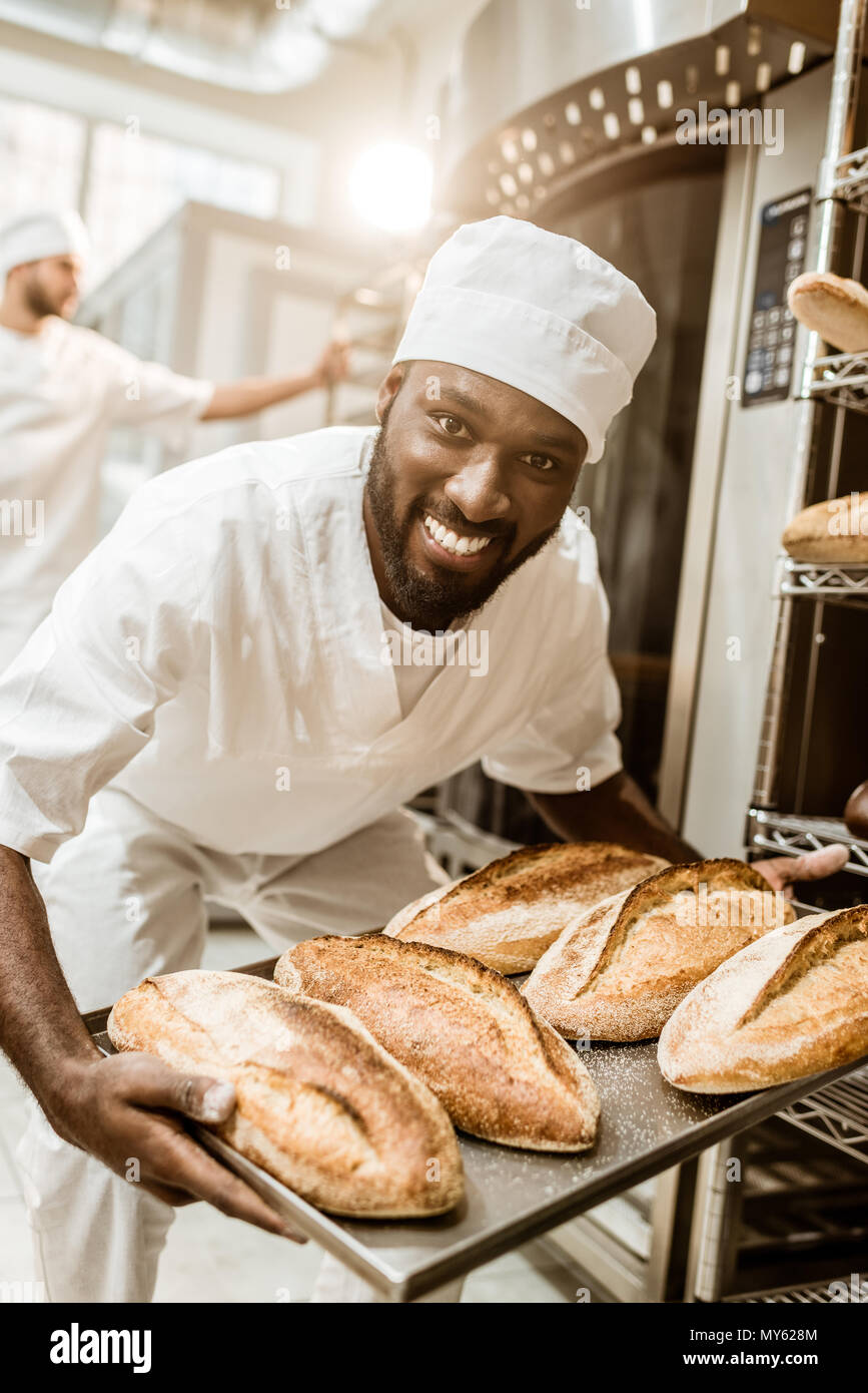 African american baker holding bread hi-res stock photography and ...