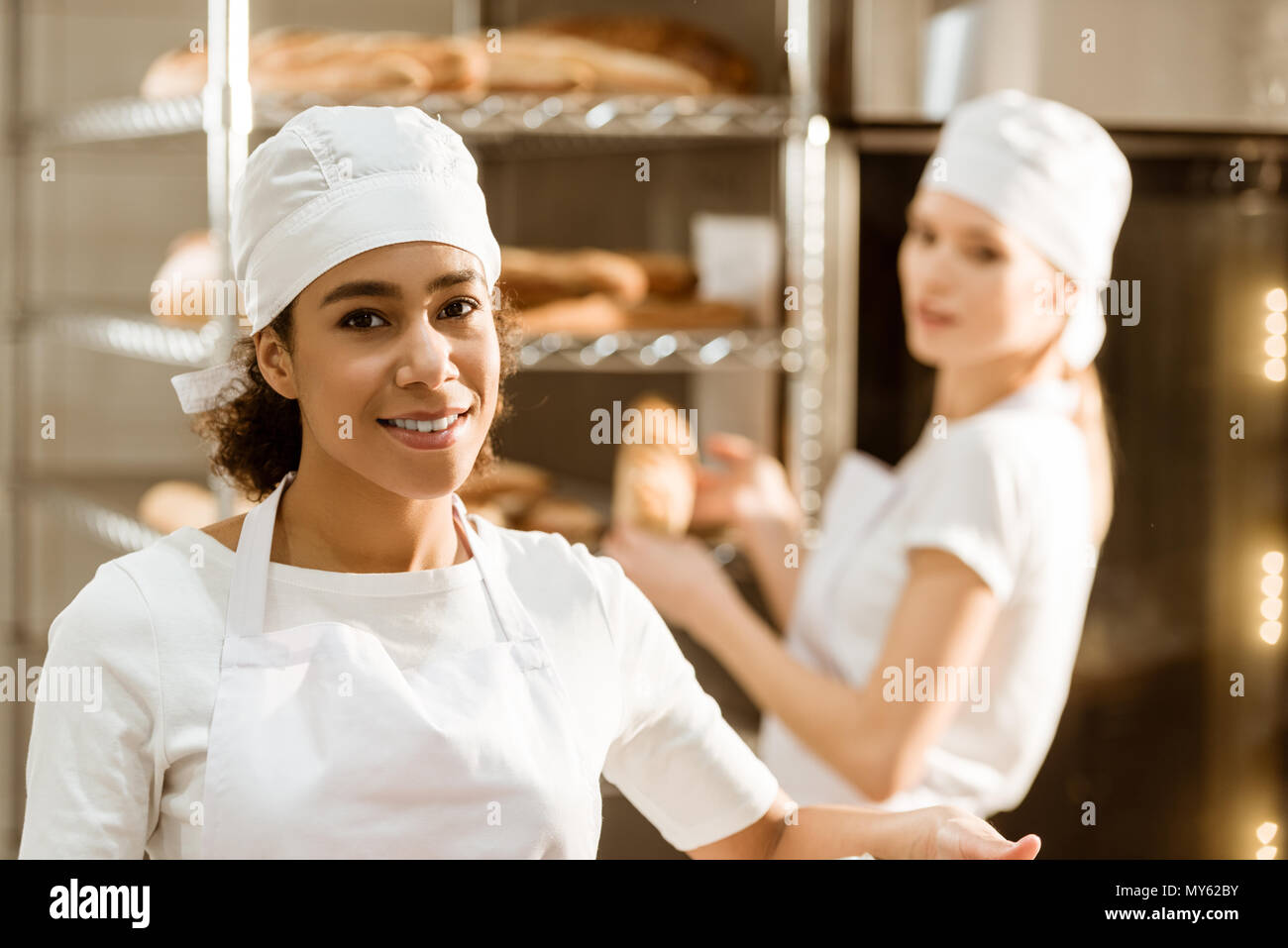 young female bakers working at baking manufacture Stock Photo - Alamy