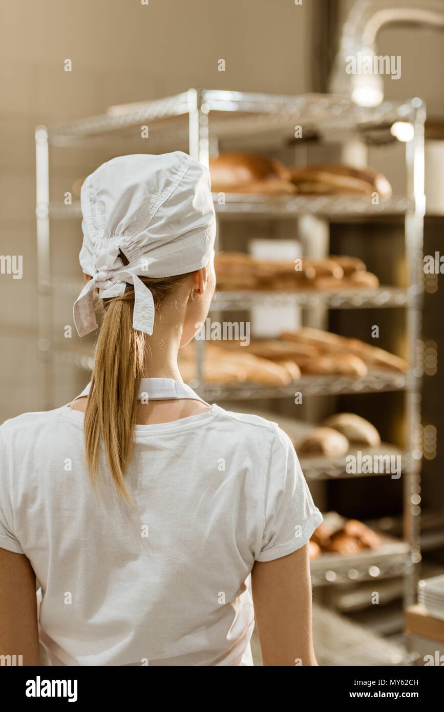 rear view of young female baker on baking manufacture Stock Photo - Alamy