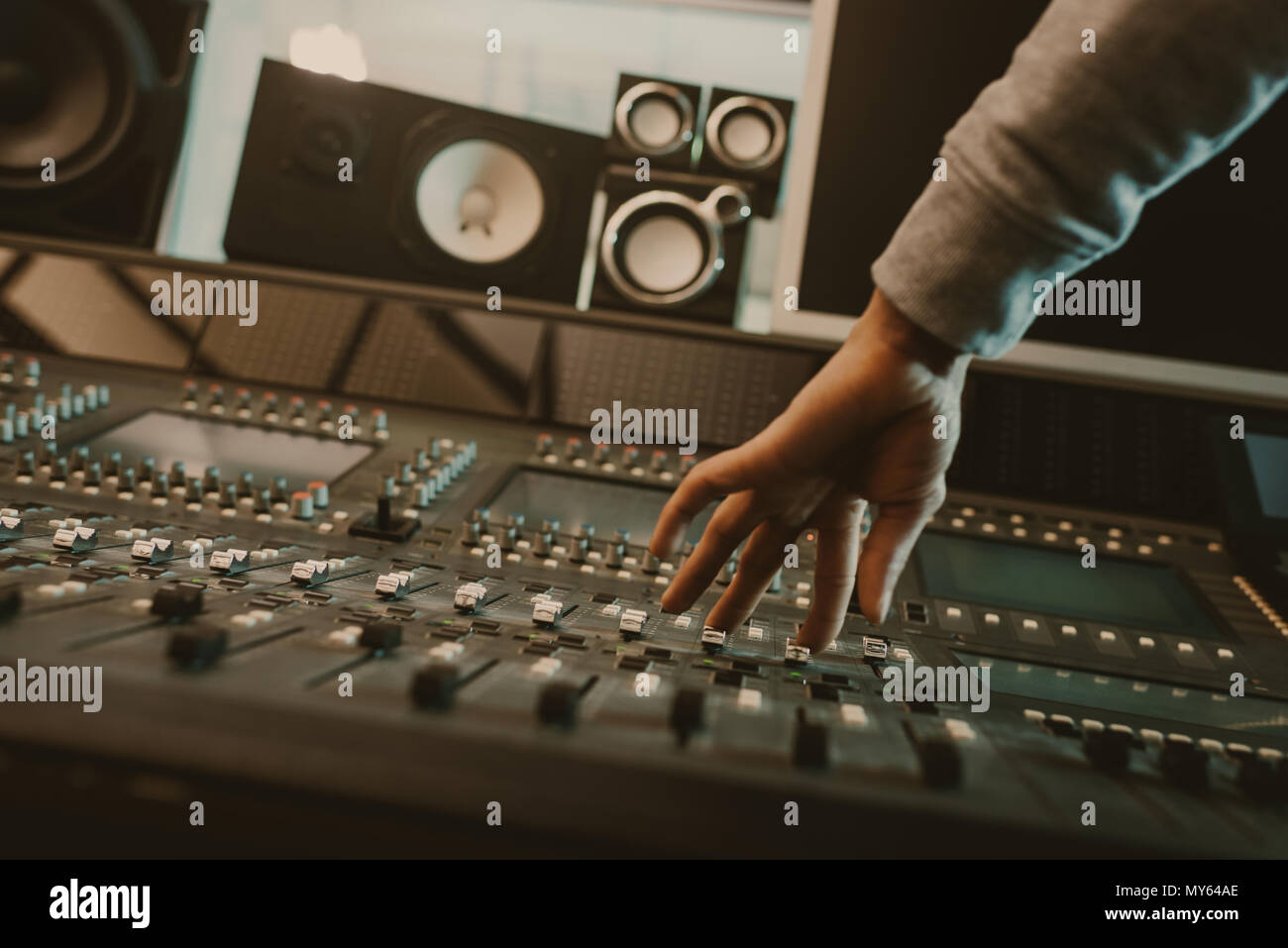 cropped shot of sound producer setting graphic equalizer at studio ...