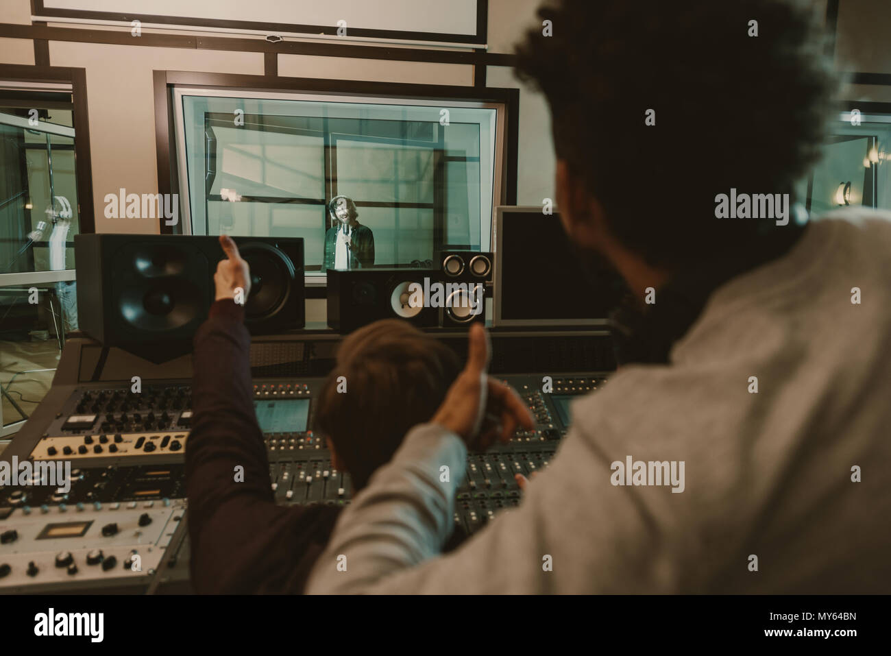 sound producers showing thumbs up to singer at recording studio Stock ...