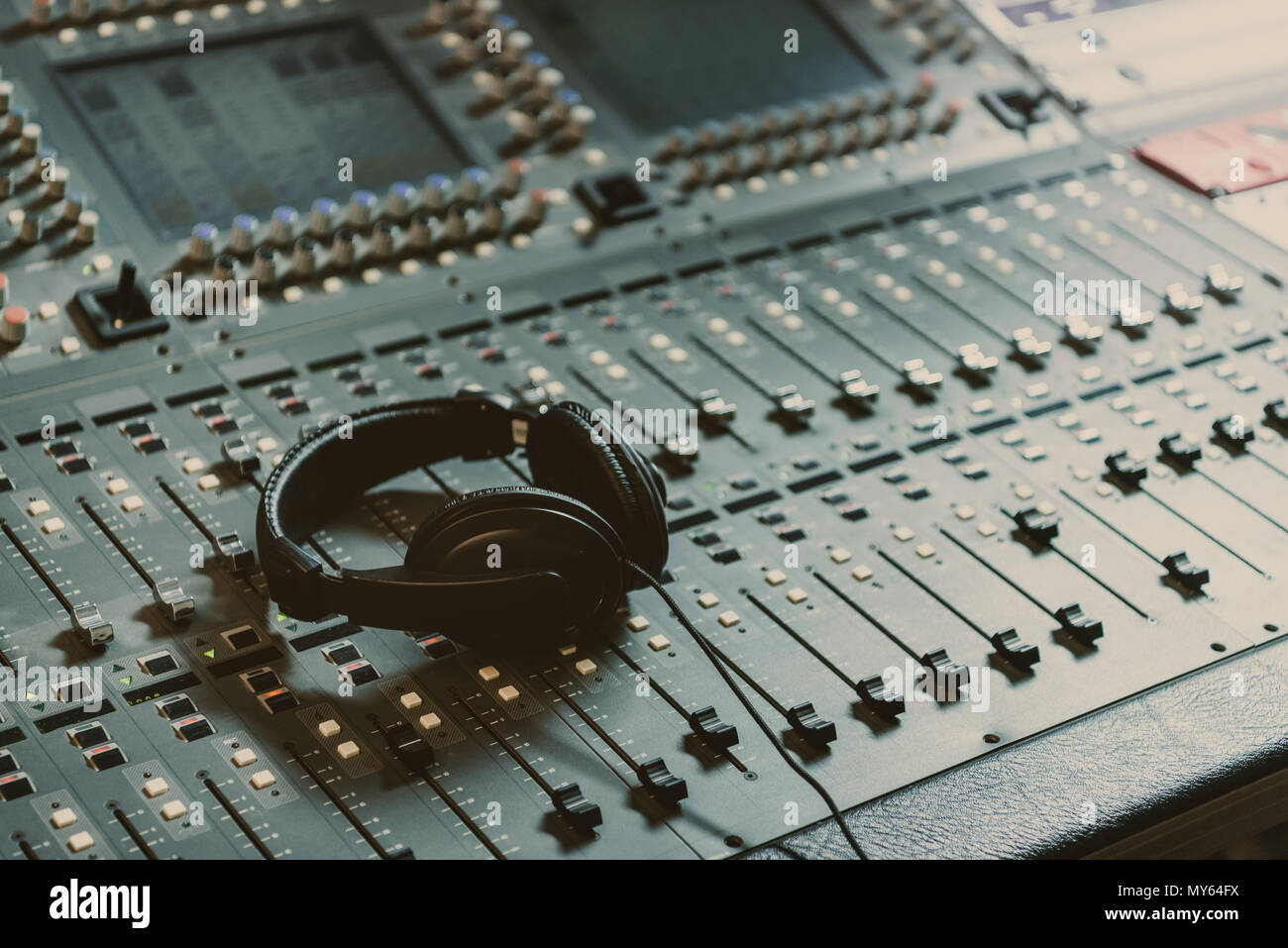 headphones on graphic equalizer at recording studio Stock Photo - Alamy