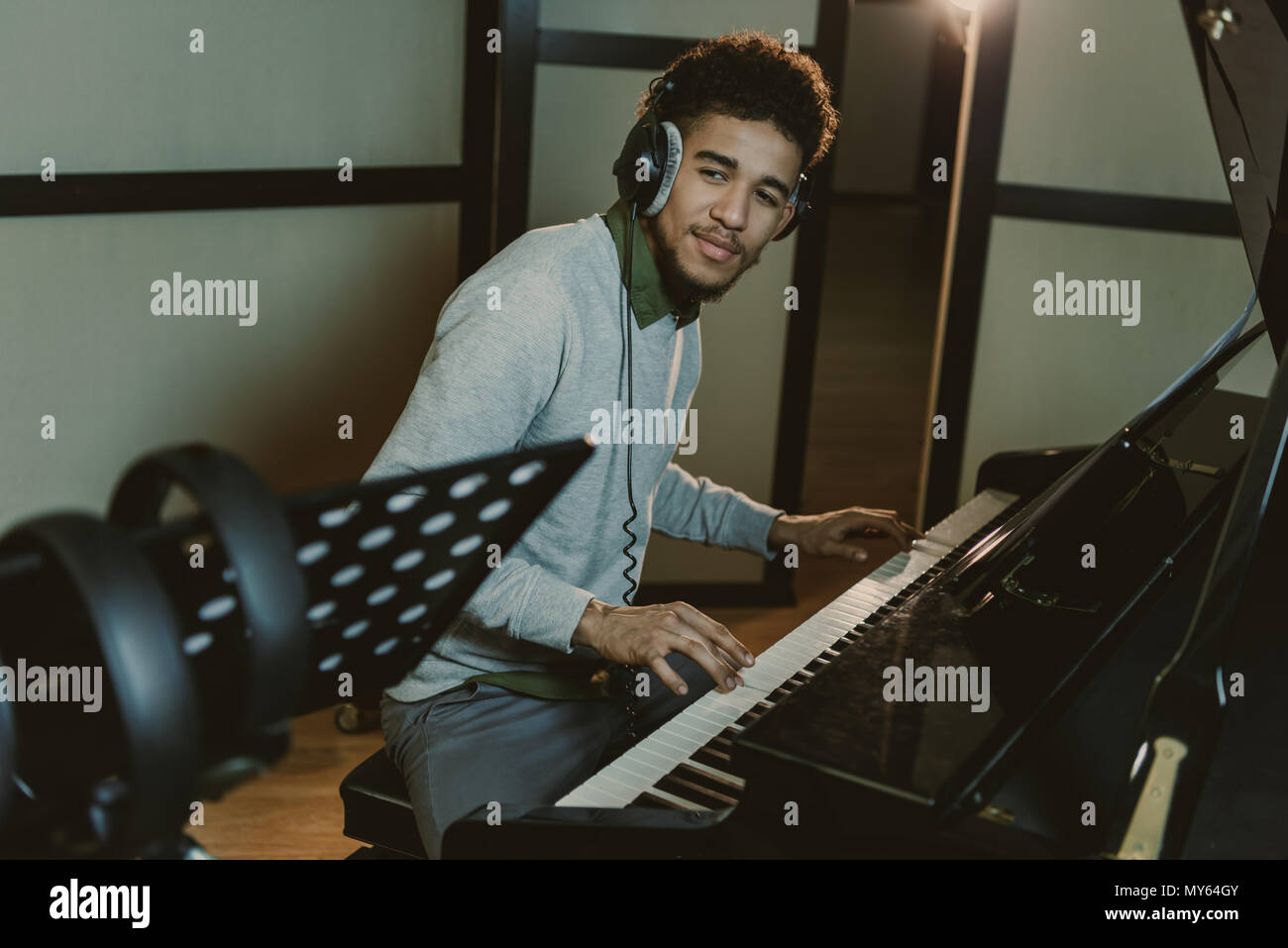 handsome smiling piano player performing song Stock Photo - Alamy