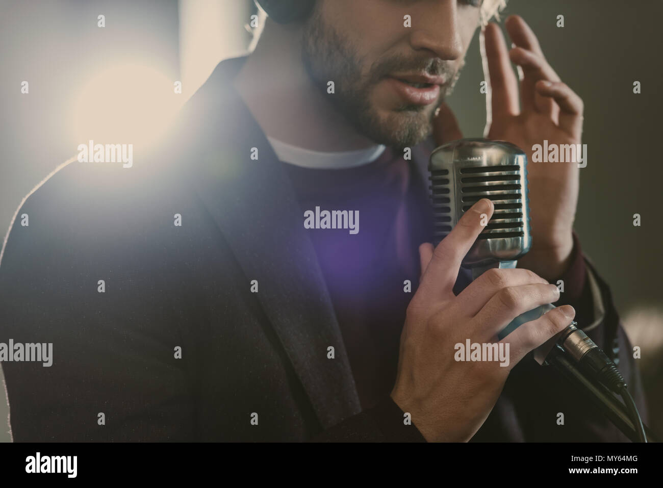 attractive young singer in headphones performing song at studio Stock ...