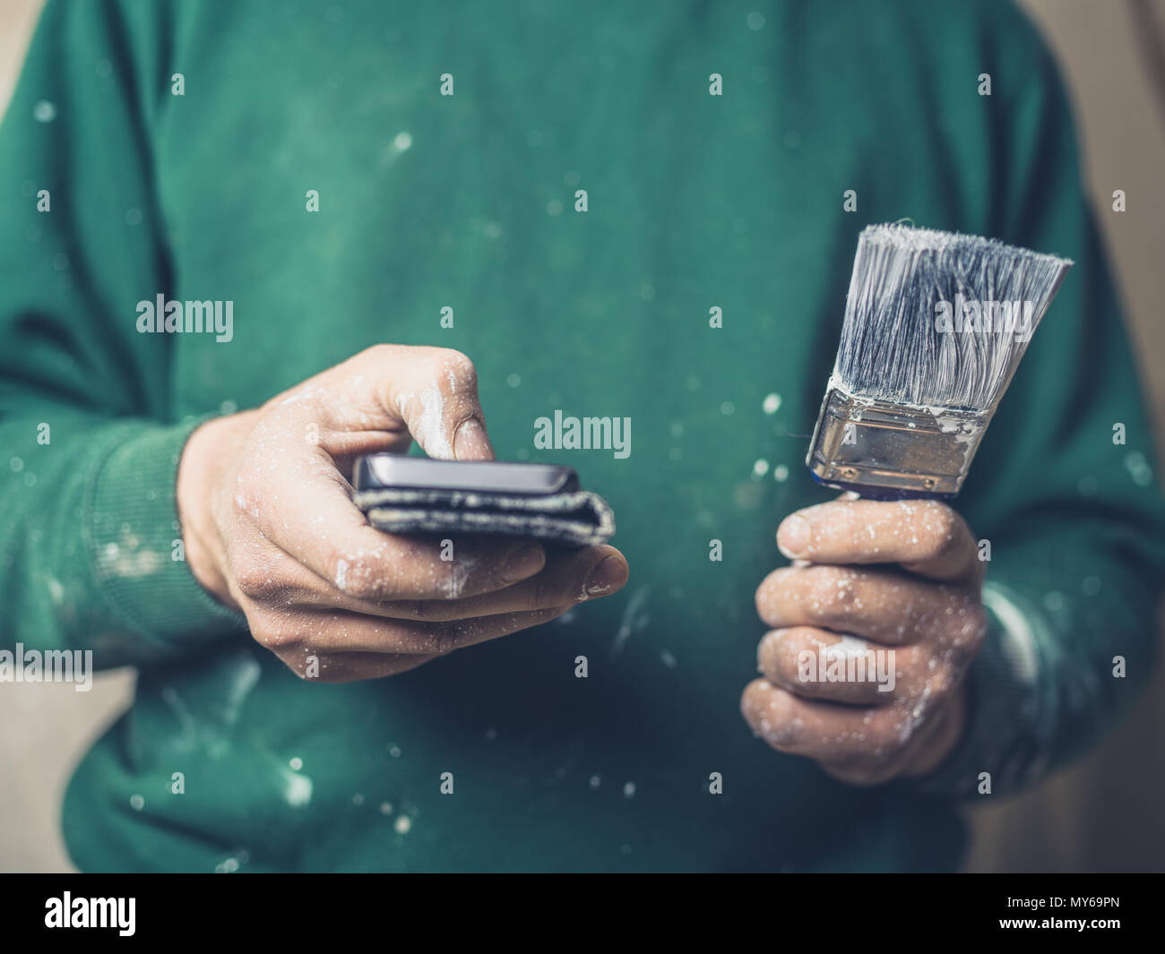 Man paintbrush mobile phone painting hi-res stock photography and ...