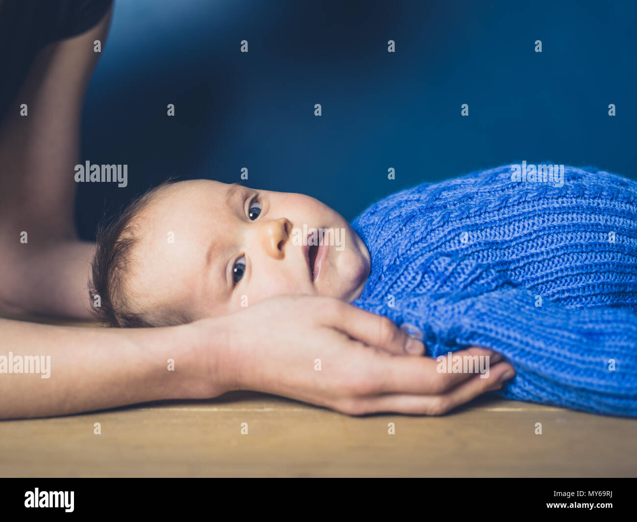 A young mother is comforting a baby Stock Photo - Alamy