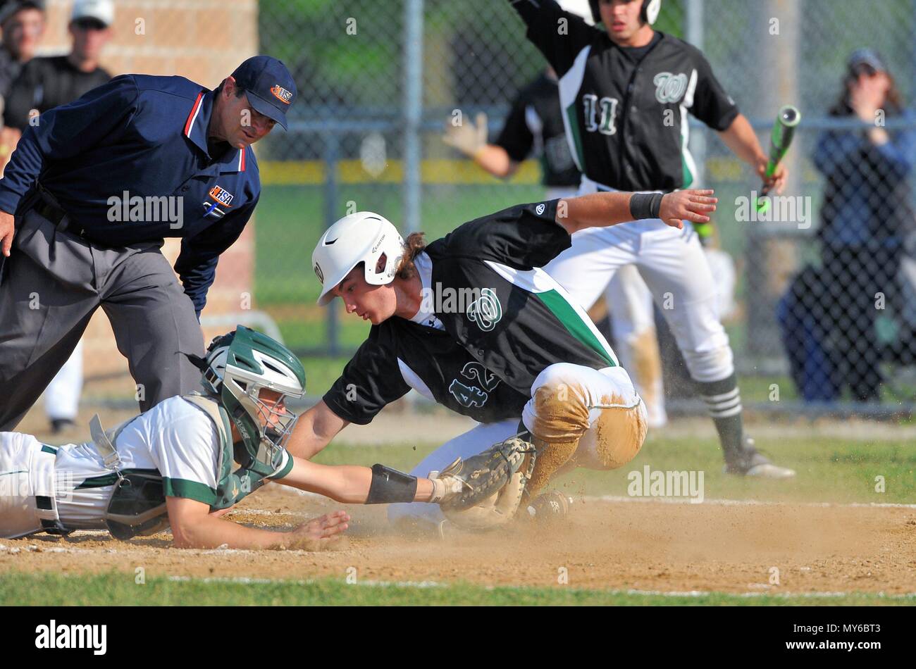Catcher making a diving tag to retire an opposing runner before he was ...
