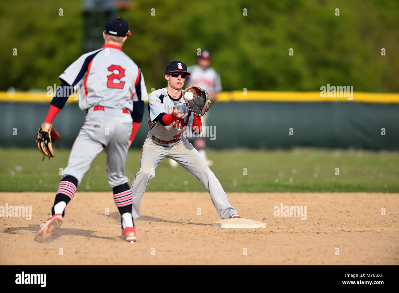 Second baseman as the middle man in a double play attempt after taking ...