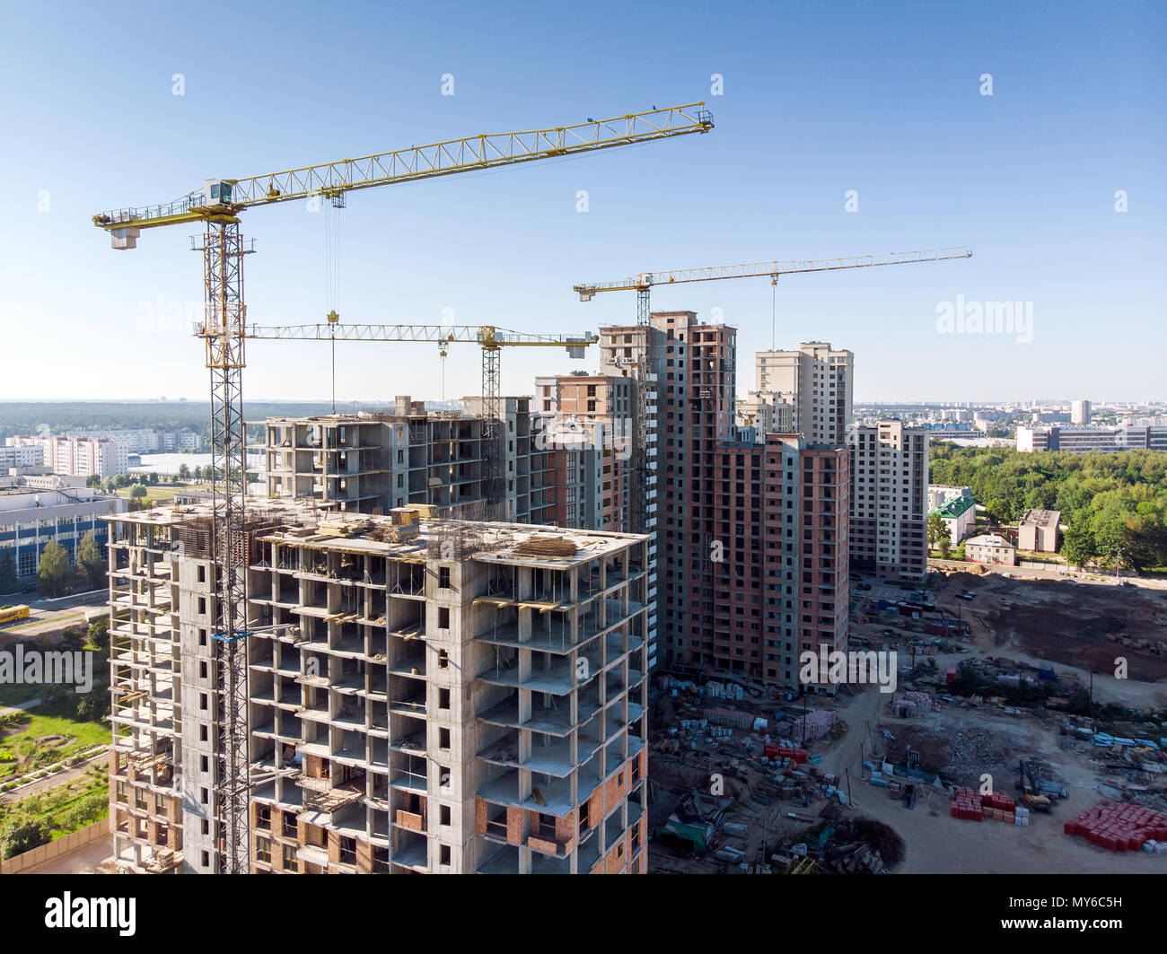 new residential building under construction against blue sky. aerial ...