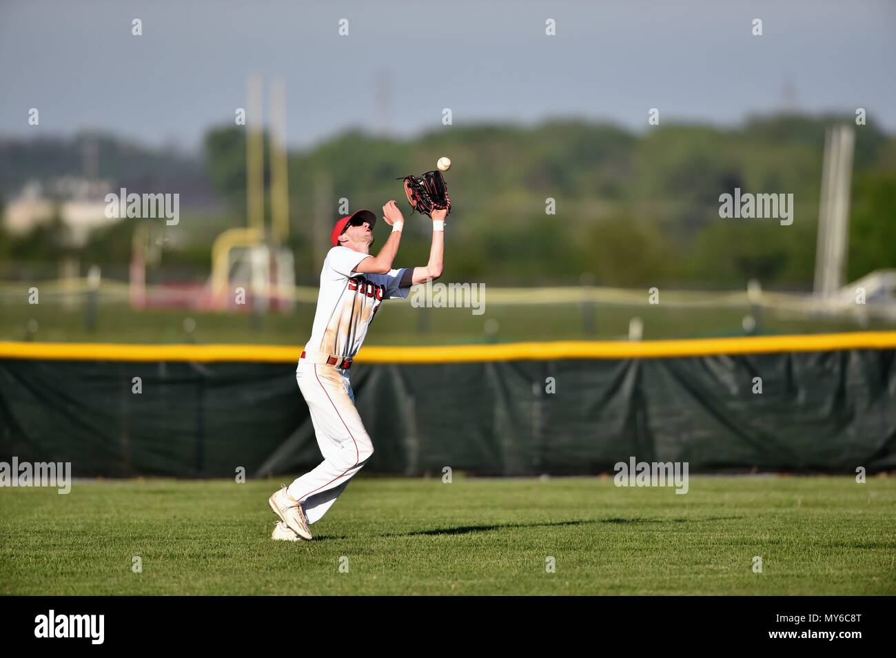 Left fielder making a running catch of a fly ball in left-center field ...